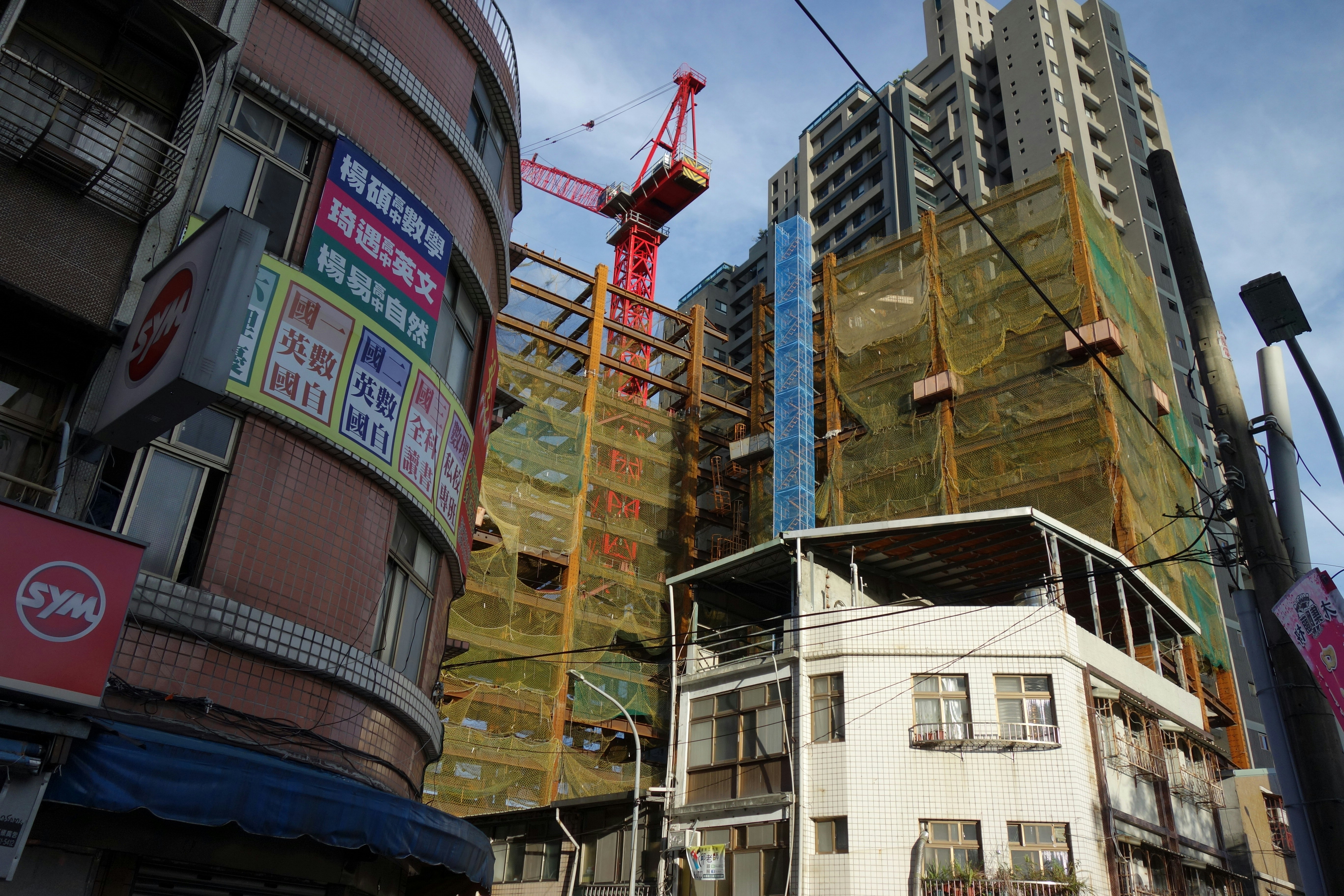red crane in front of building