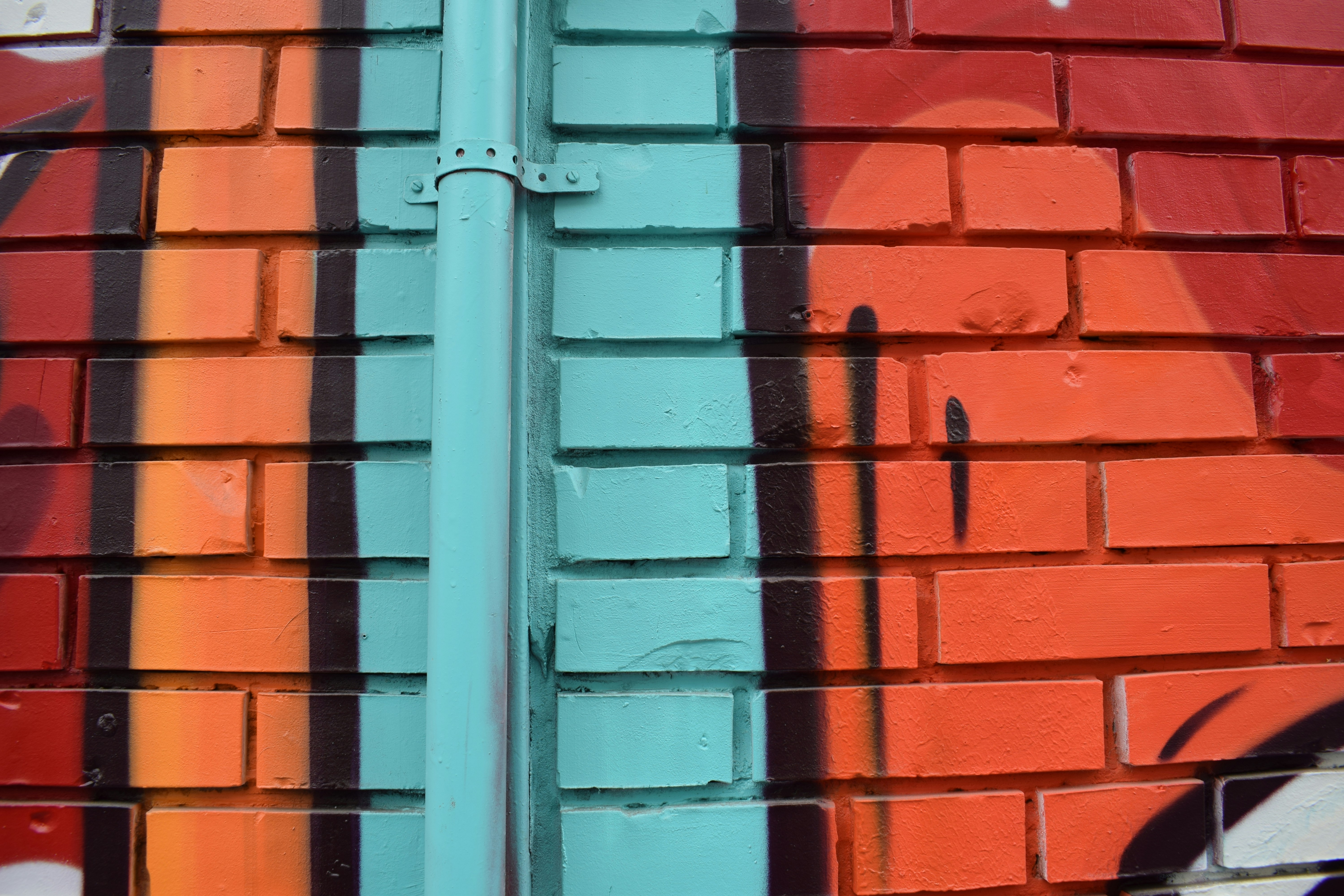 blue metal door on orange brick wall
