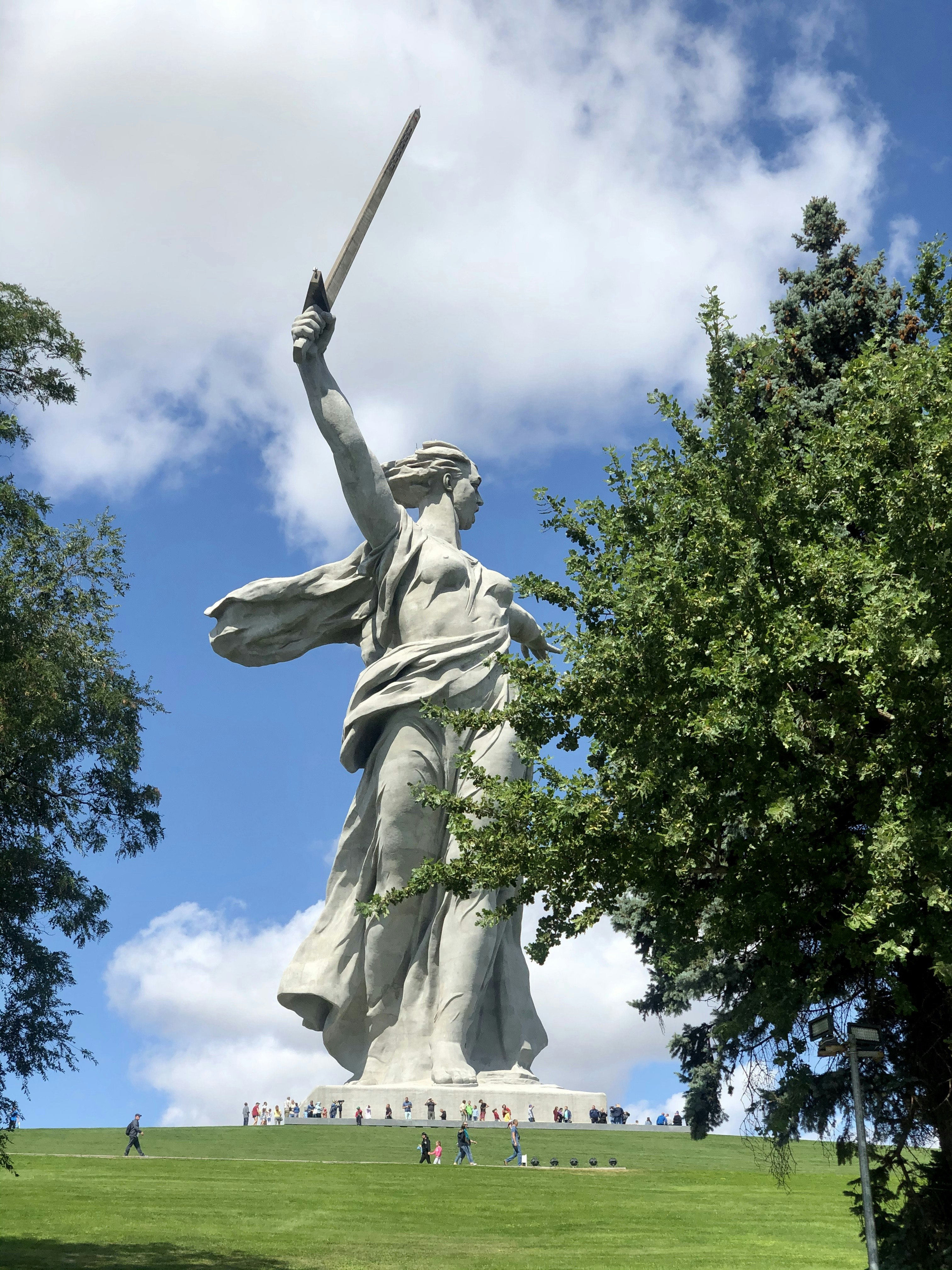 Sword Held High over a Green Hill: A Monumental Statue Reaching for the Sky
