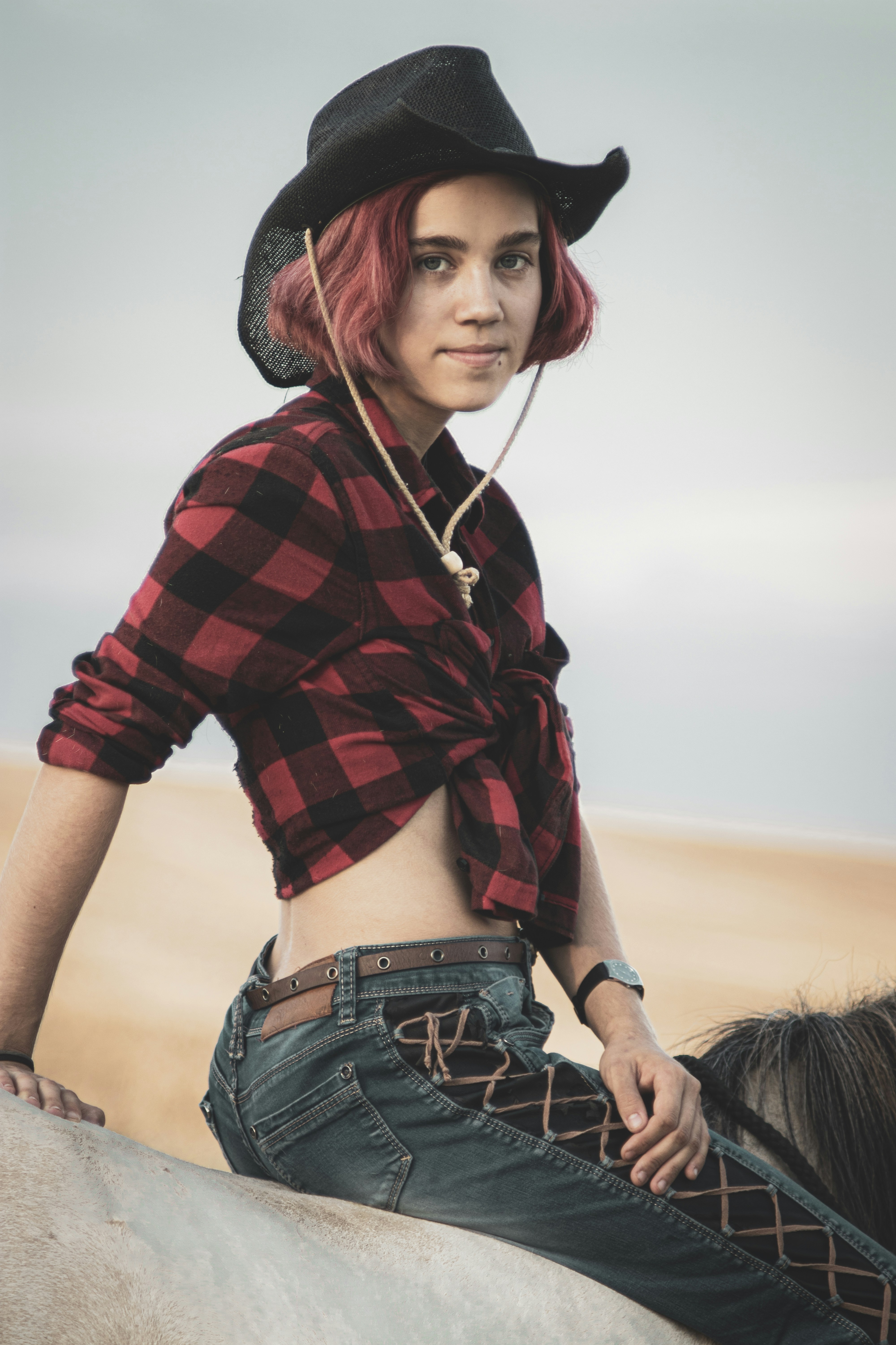 Woman in red and black checkered dress shirt and blue denim bottoms ...