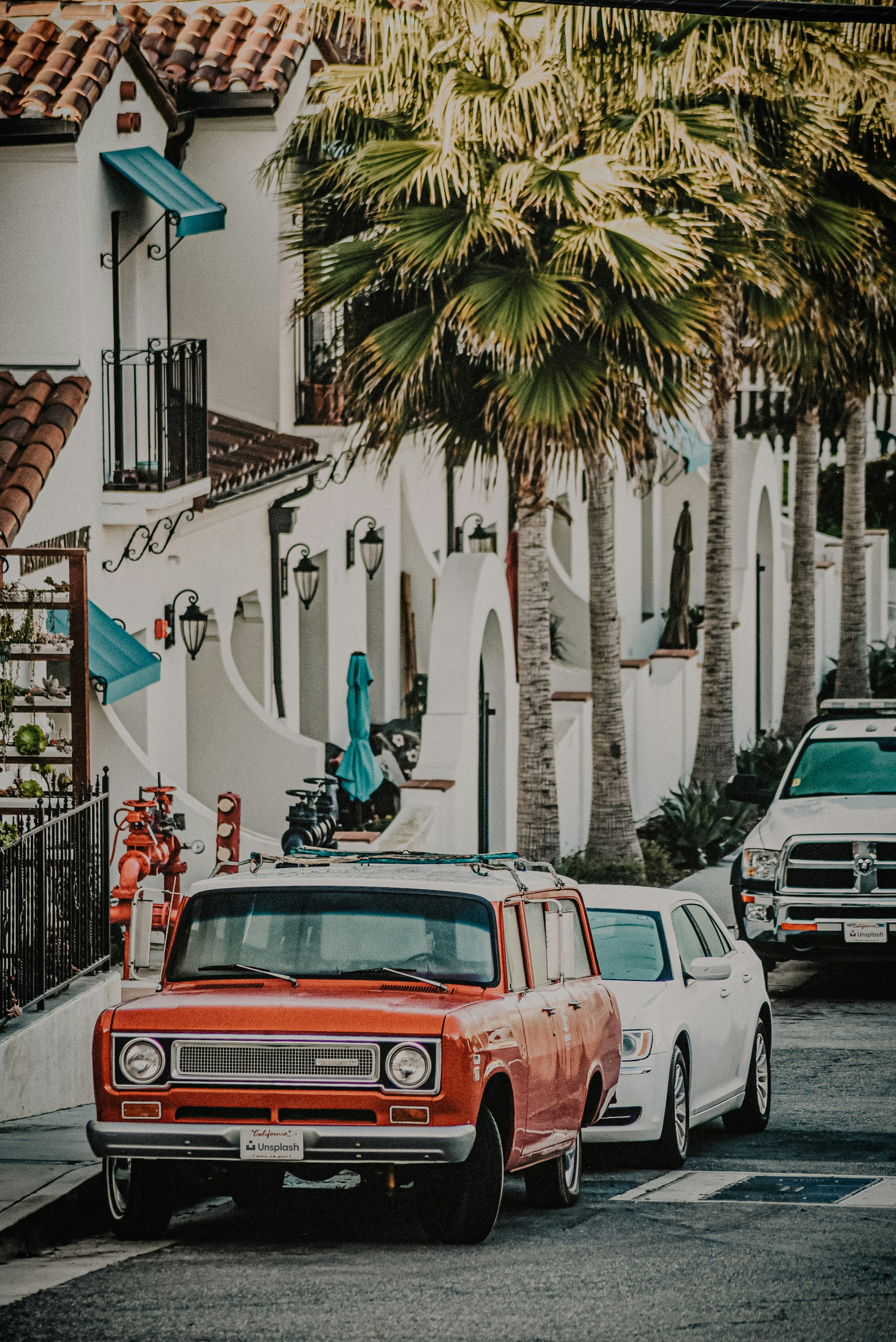 Red Van on a Palm-Shaded Street in a Mediterranean Village