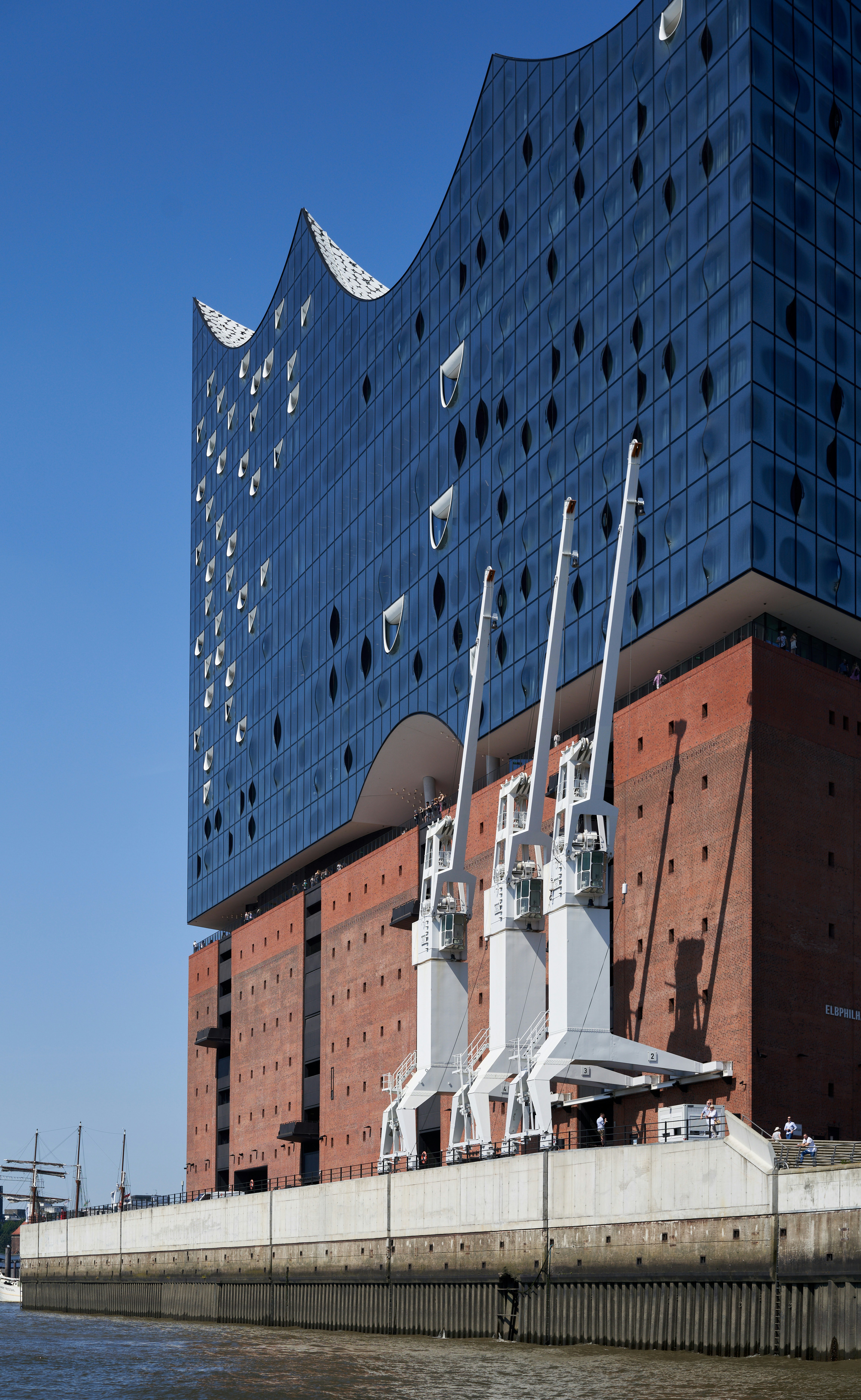 Blue Steel and Brick: A Dockside Facade with Sails of Light