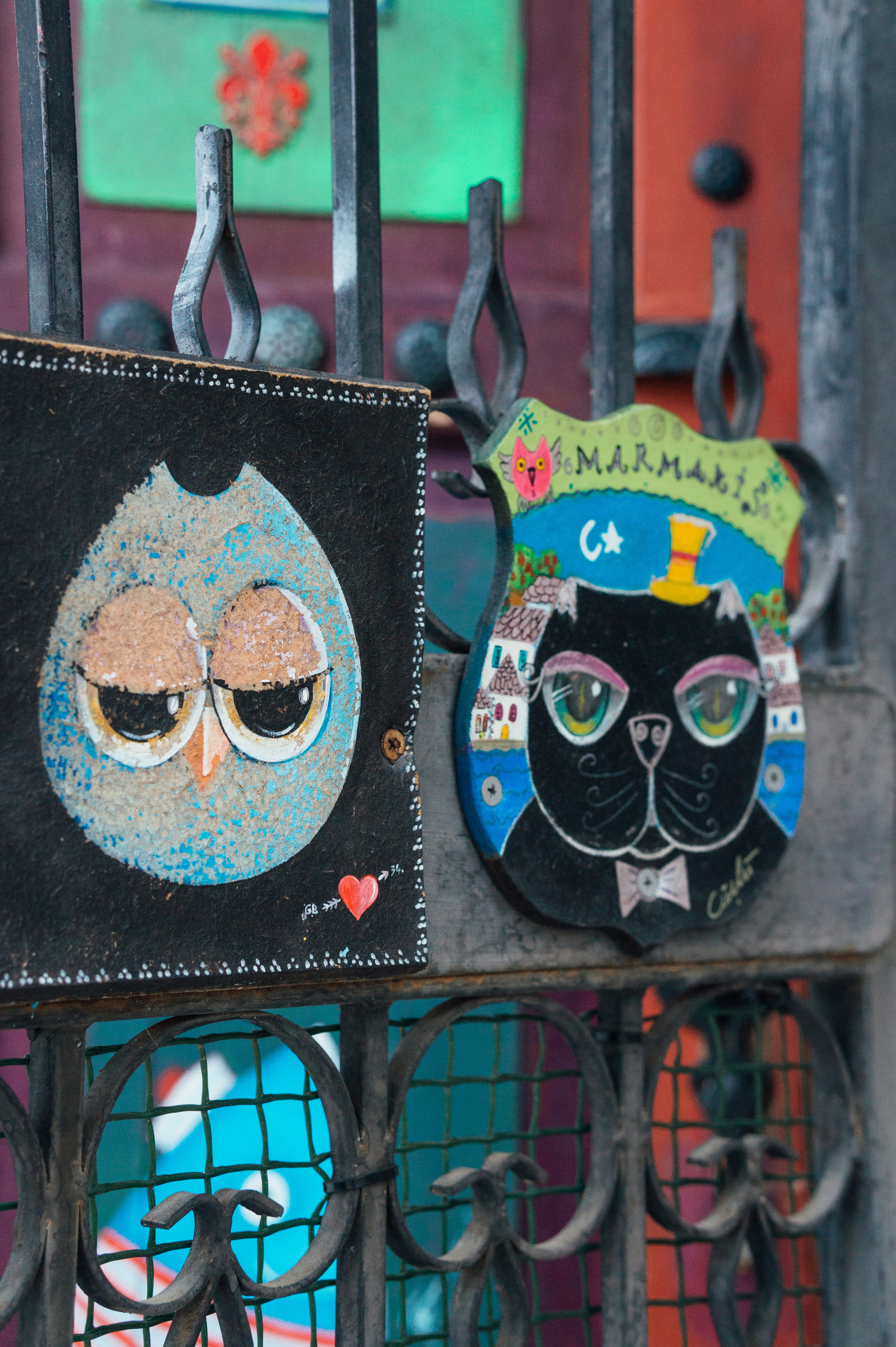Top-Hatted Cat Shield on a Wrought-Iron Gate