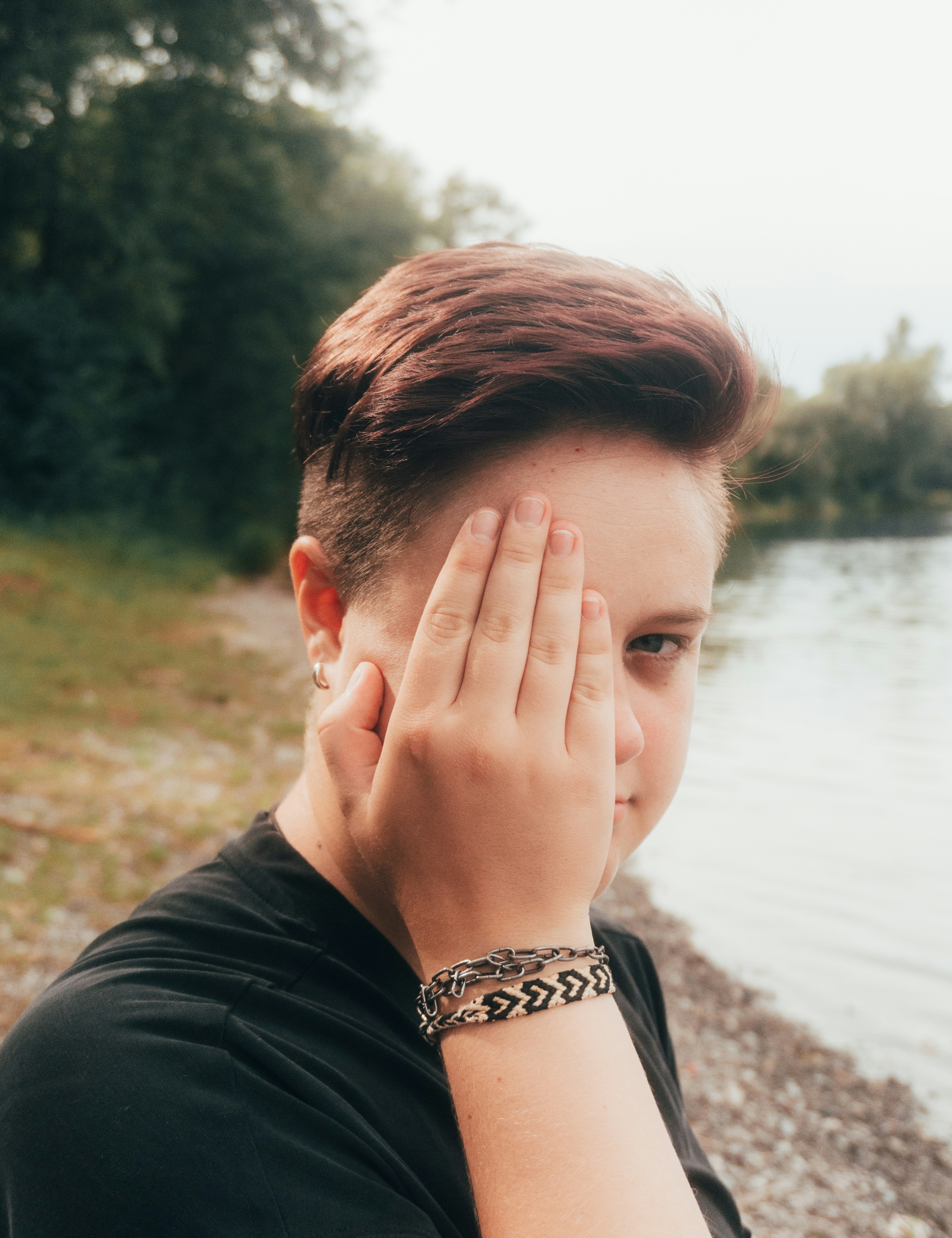 Hidden Gaze by the Lakeside: Portrait Through a Hand