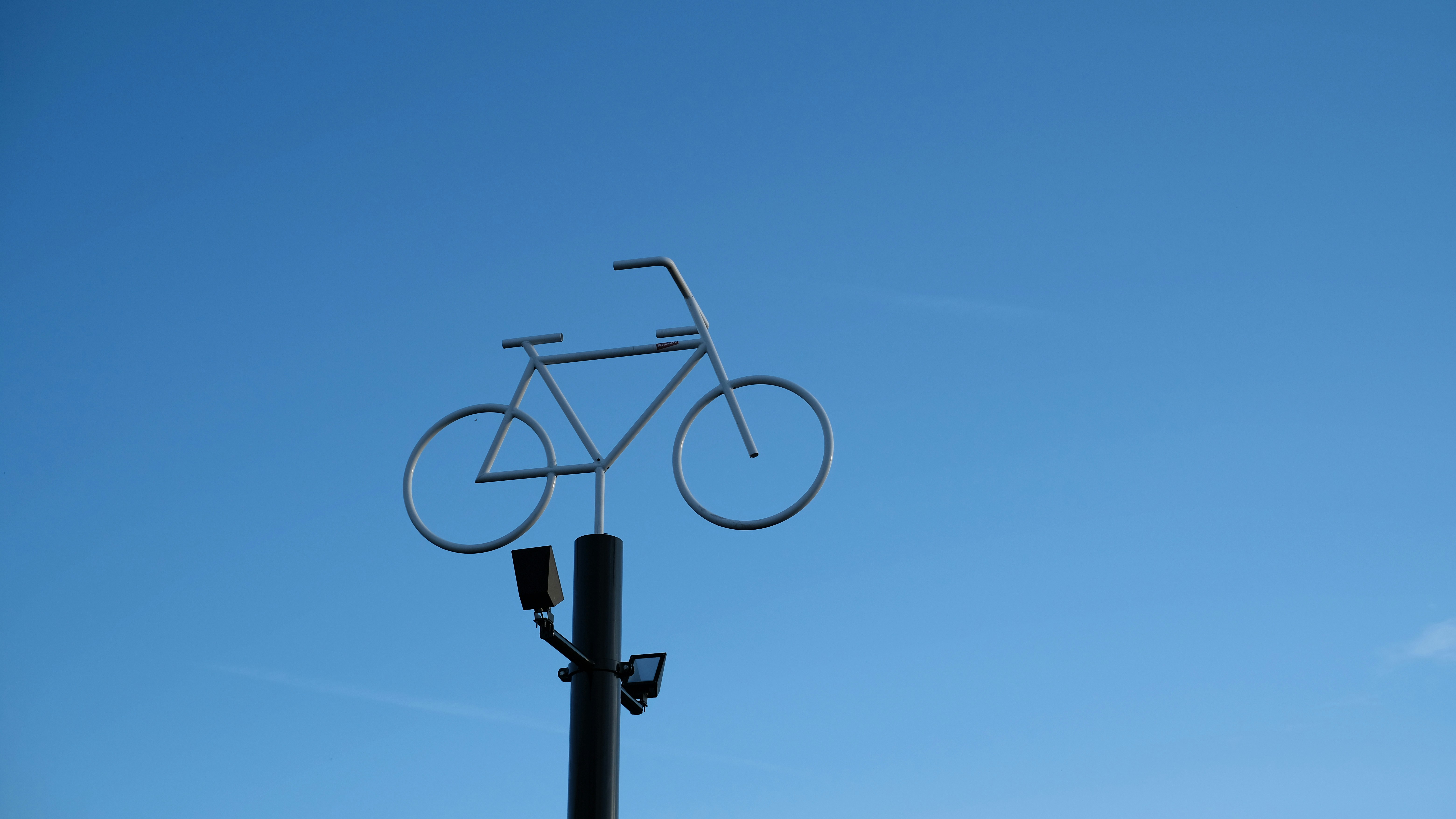 black metal street light under blue sky during daytime