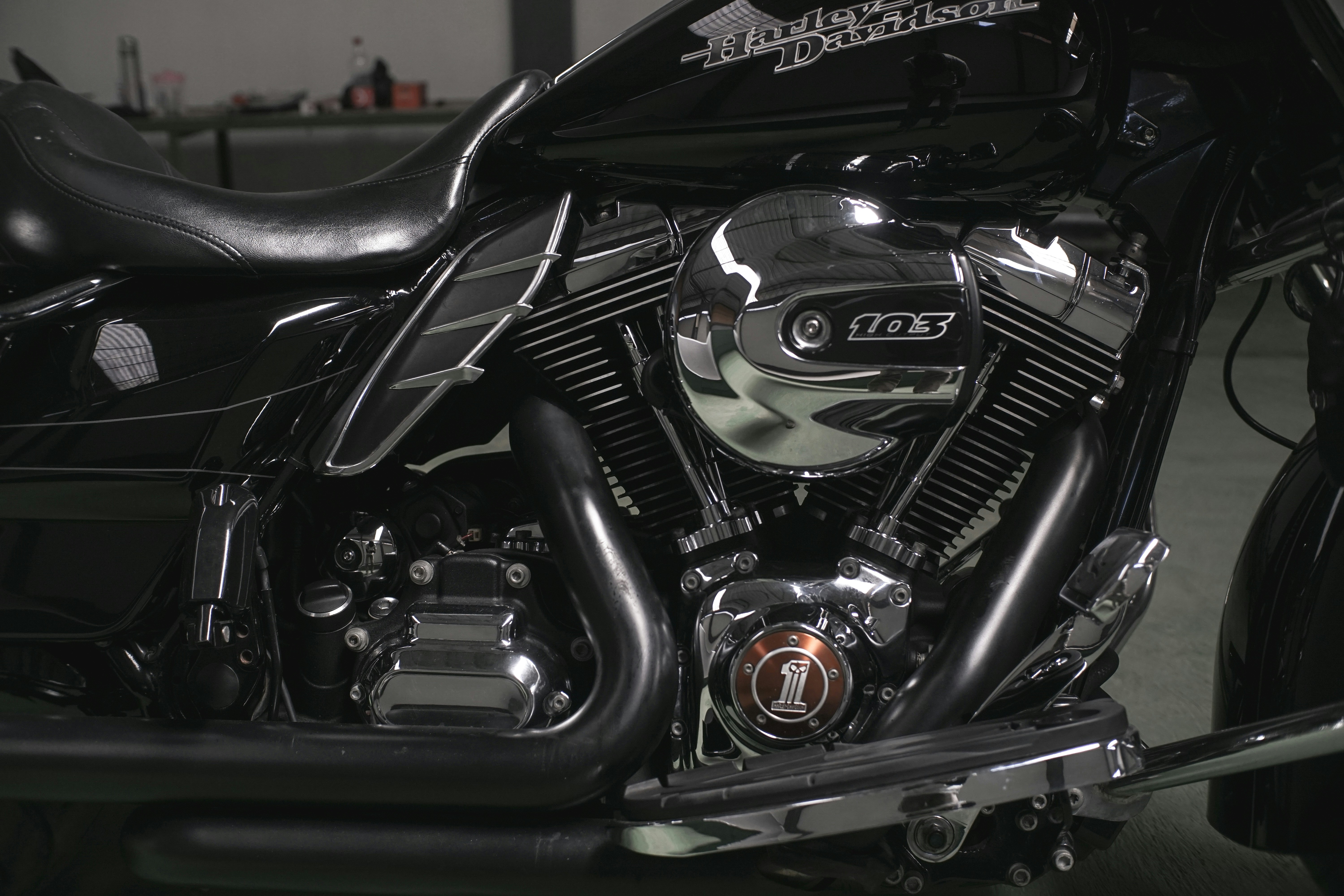 Close-up of a motorcycle engine with gleaming chrome components and intricate details.