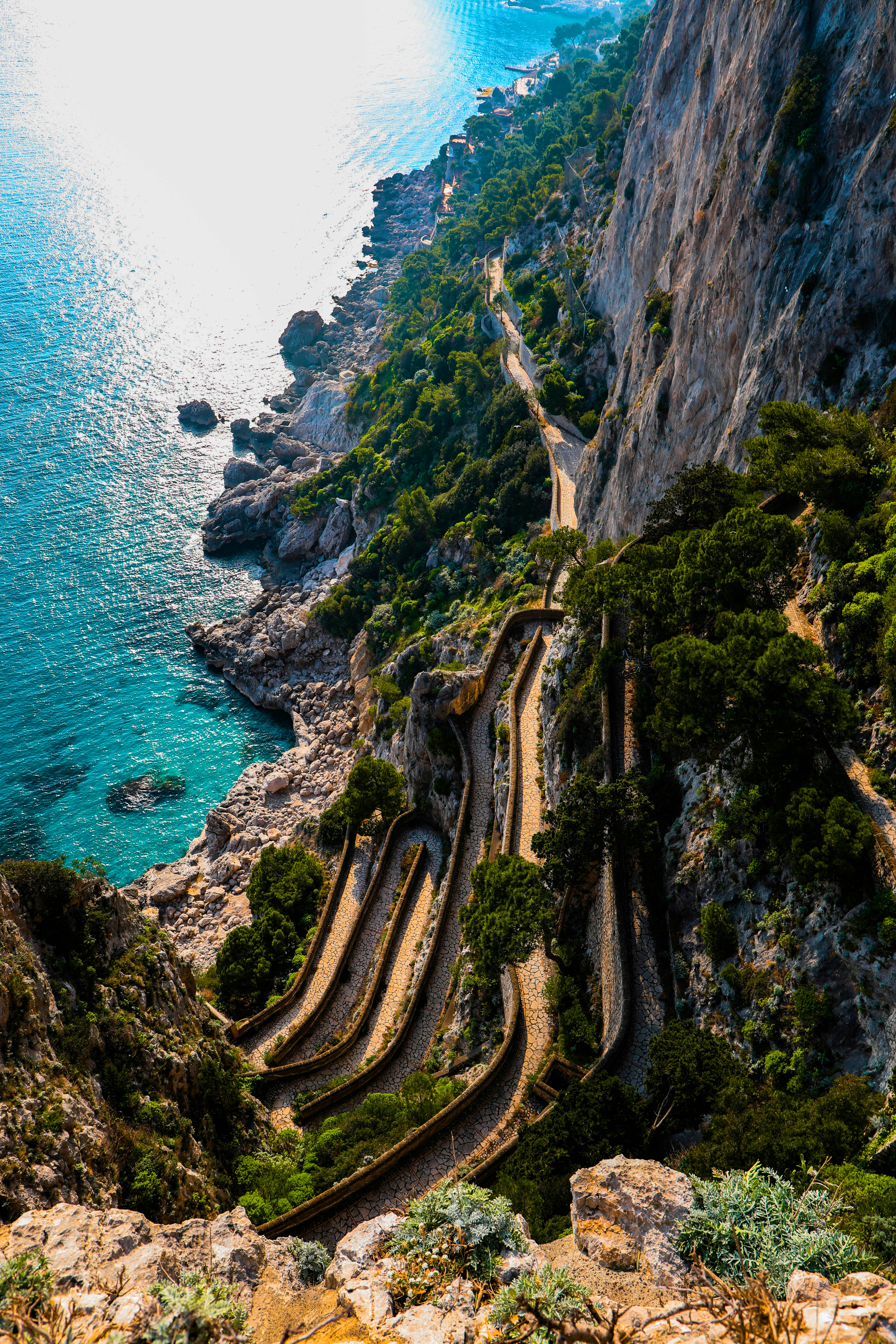 Green and brown mountain beside body of water during daytime photo ...
