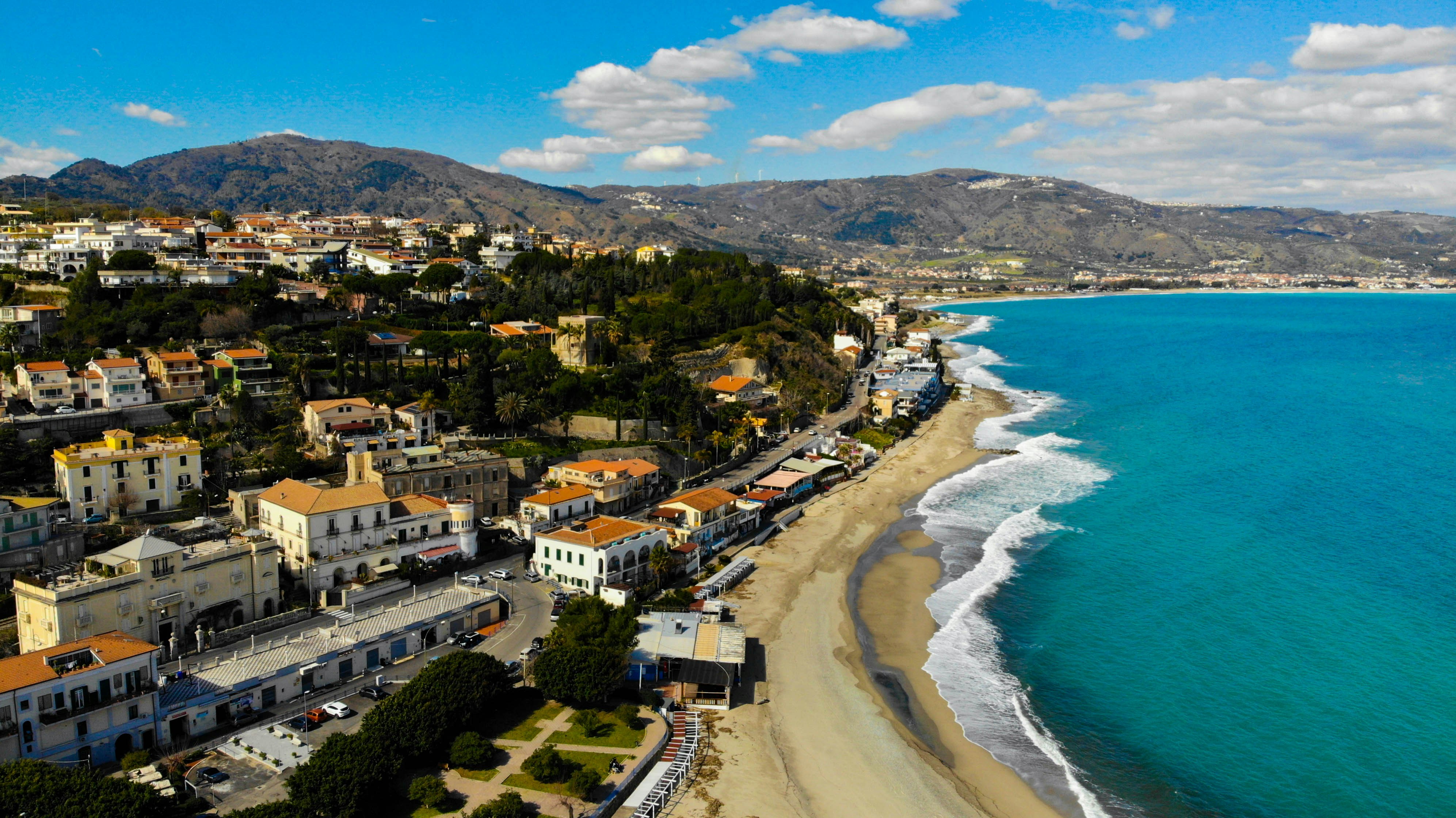 Terracotta Tides: Aerial Portrait of a Sunlit Coastal Village