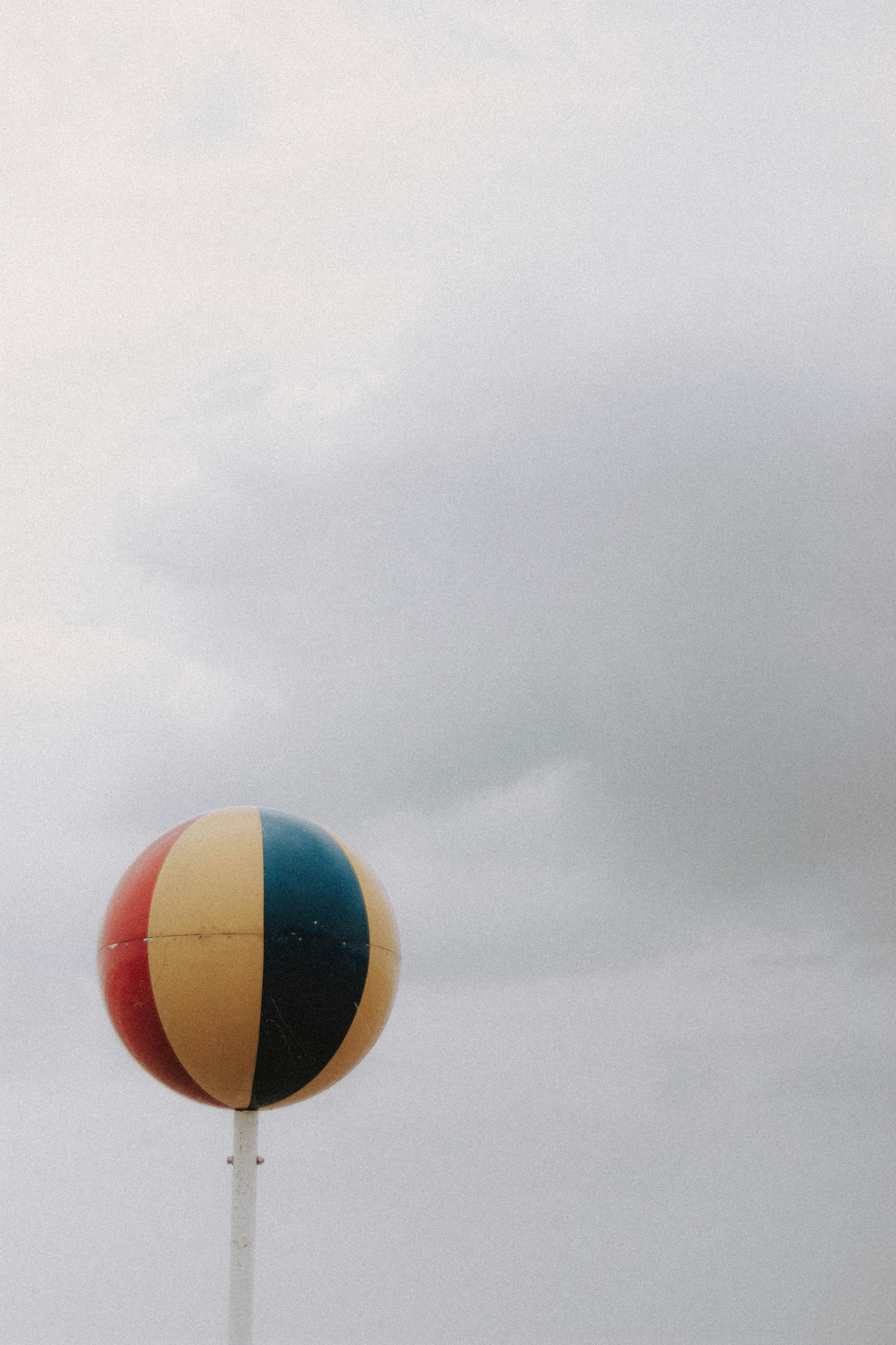 blue and white hot air balloon under white clouds