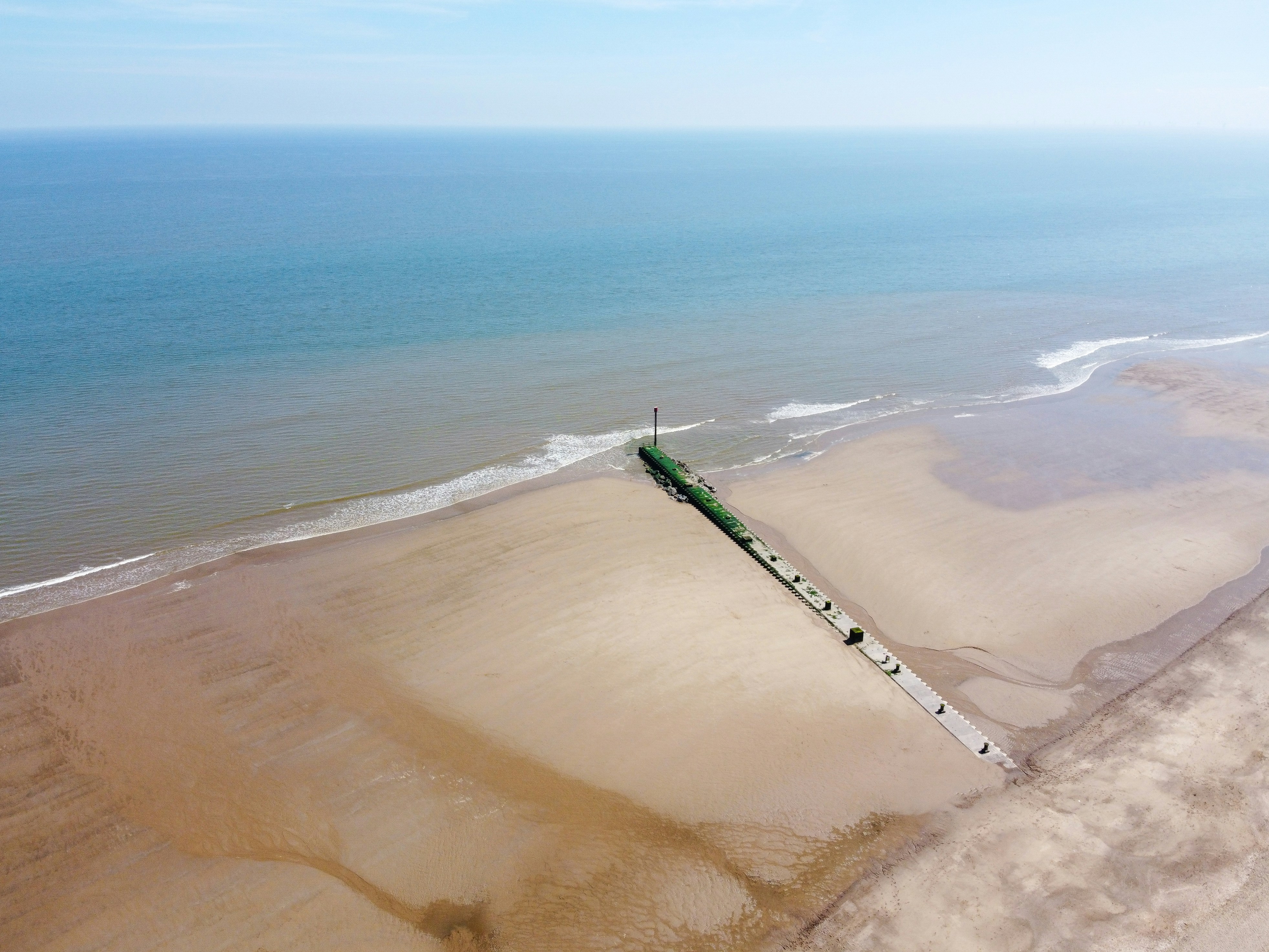Verdant Jetty at the Ocean's Quiet Edge