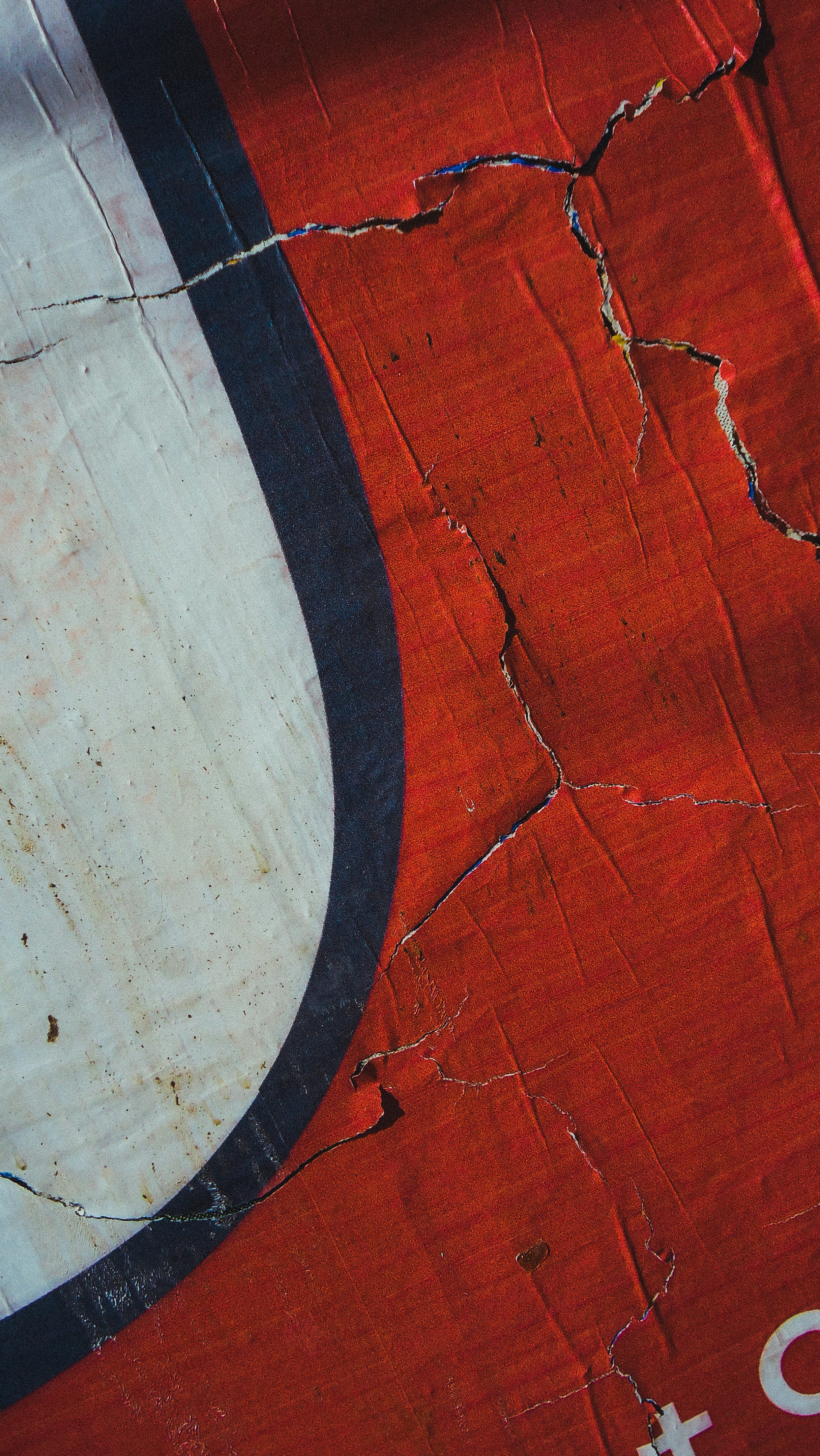 Crackled Circular Emblem on a Weathered Red Canvas