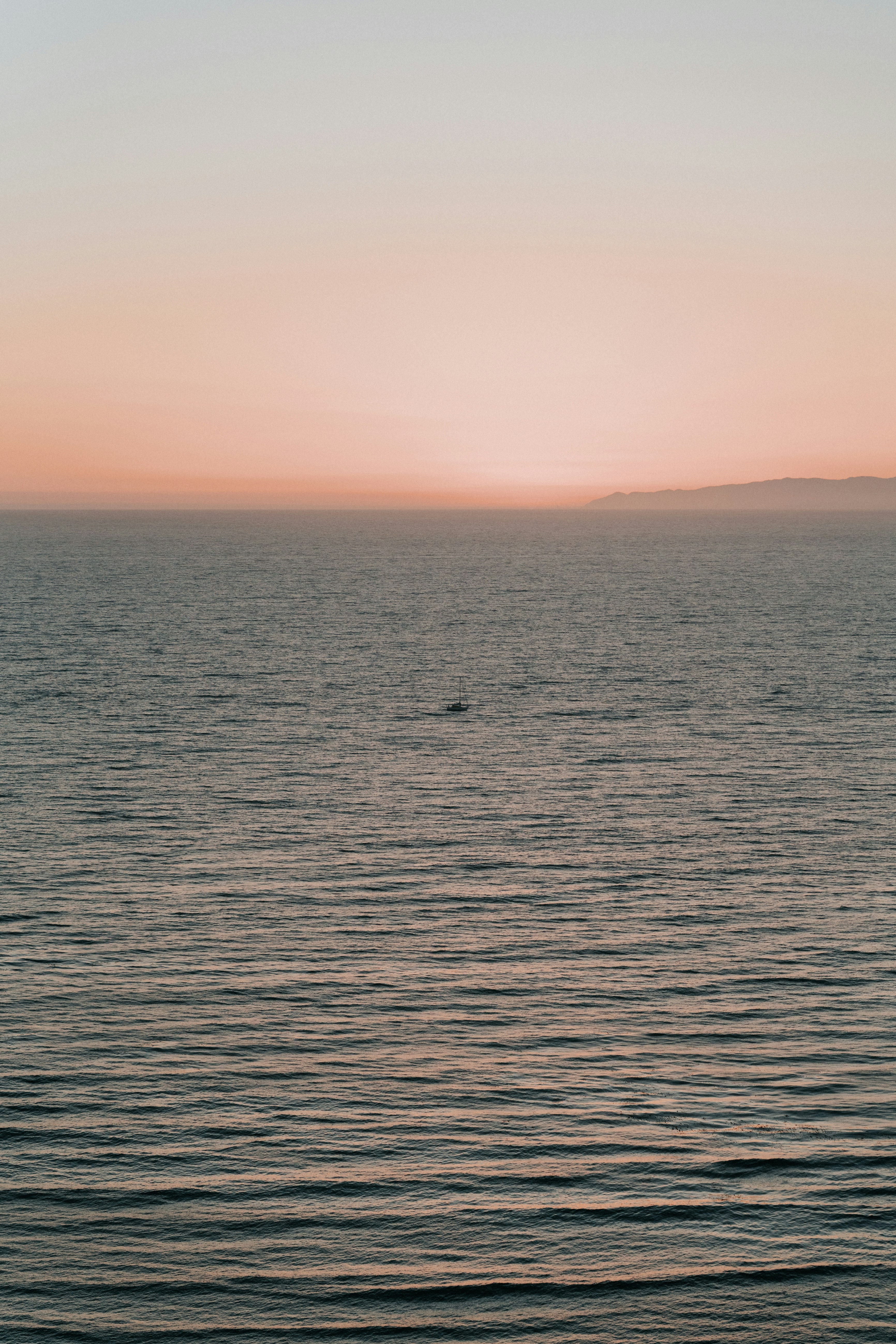 A small boat in the open ocean, at sunsetkaleb tapp