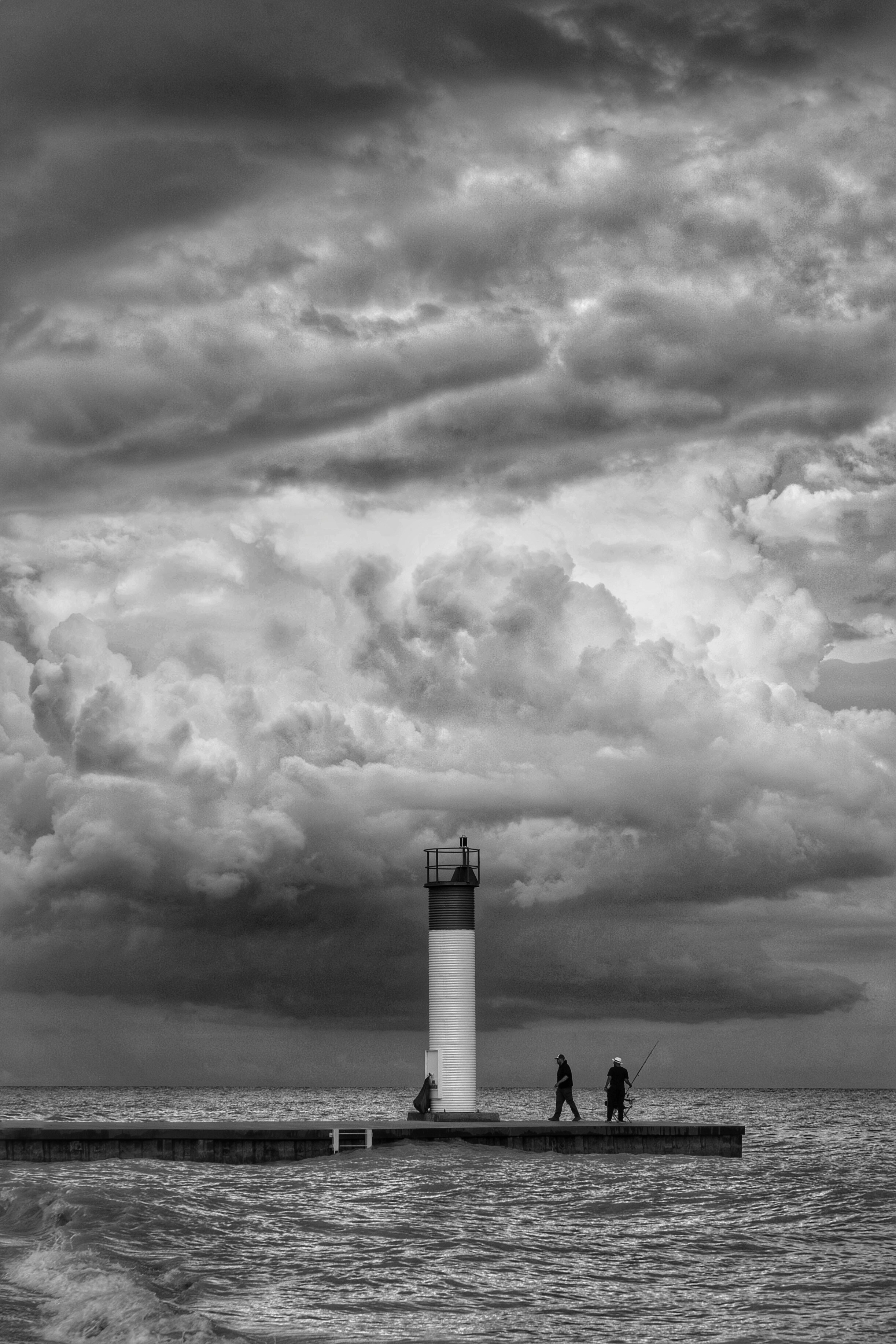 Grayscale photo of lighthouse under cloudy sky photo – Free Grey Image ...