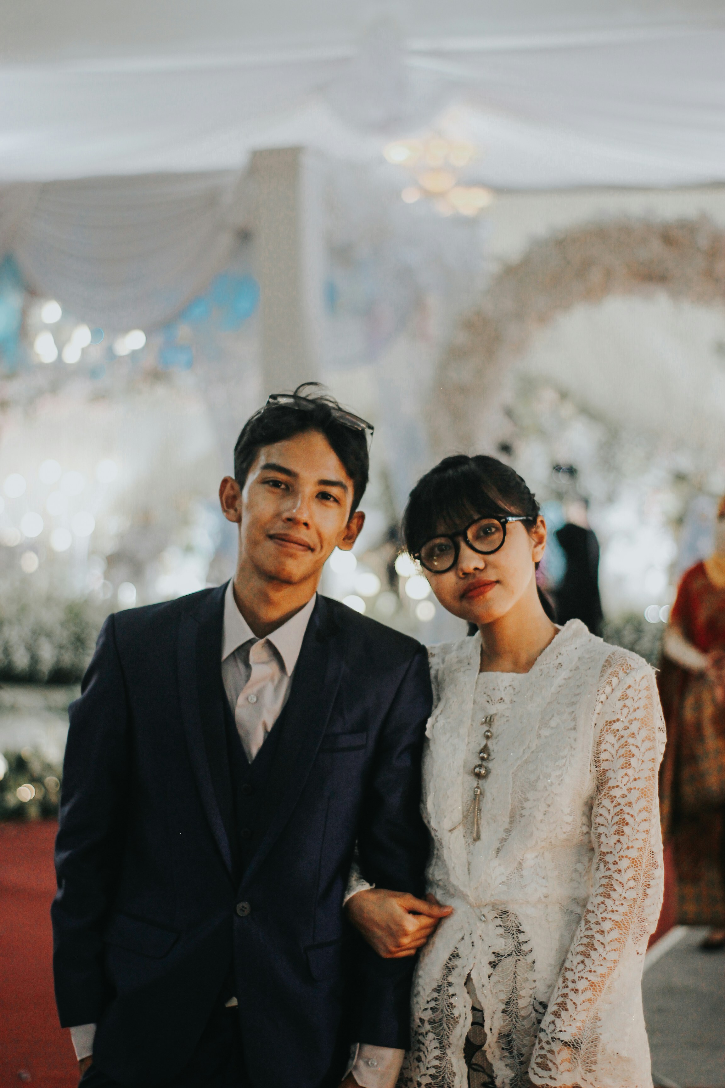 Navy Suit, Ivory Lace: A Quiet Moment Under Wedding Glow