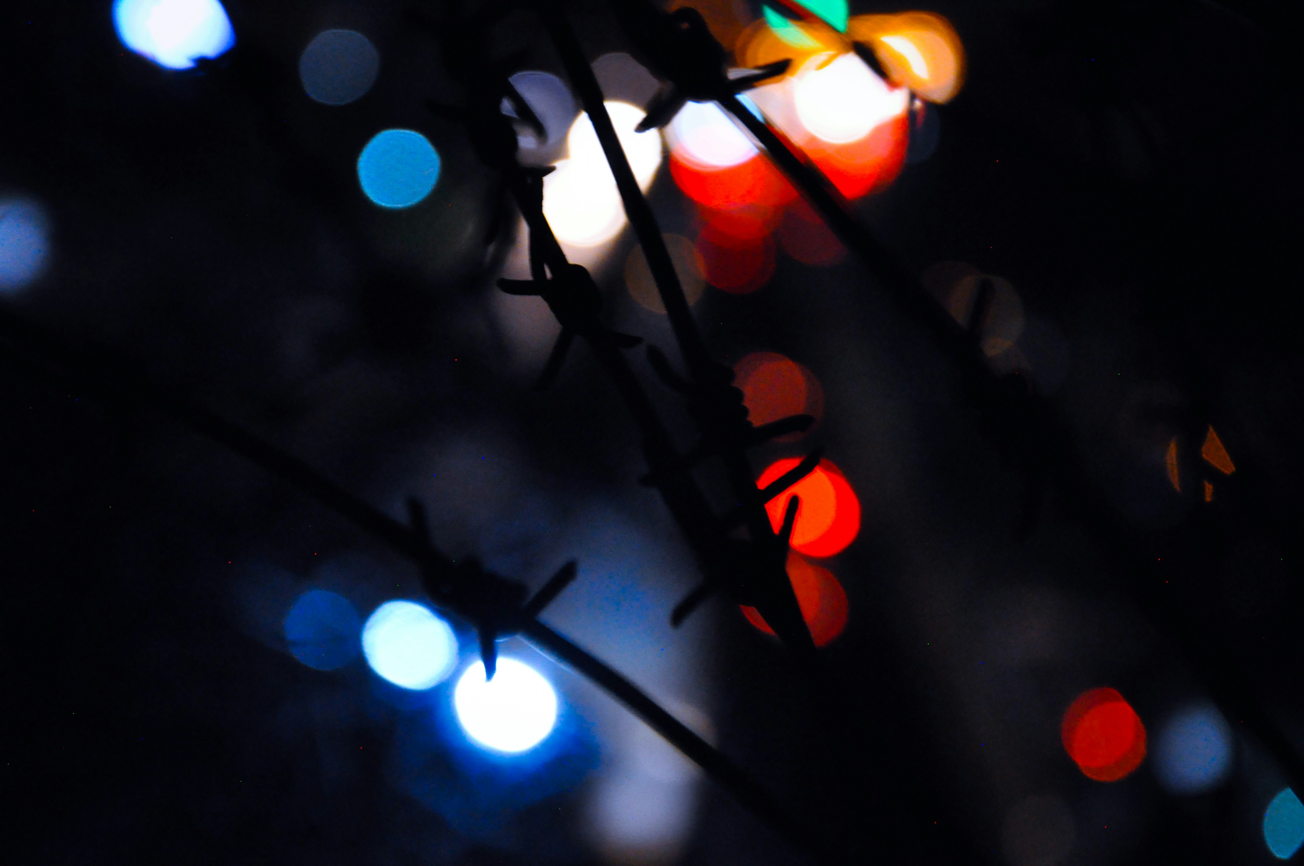 Colorful bokeh of string lights against a dark background.