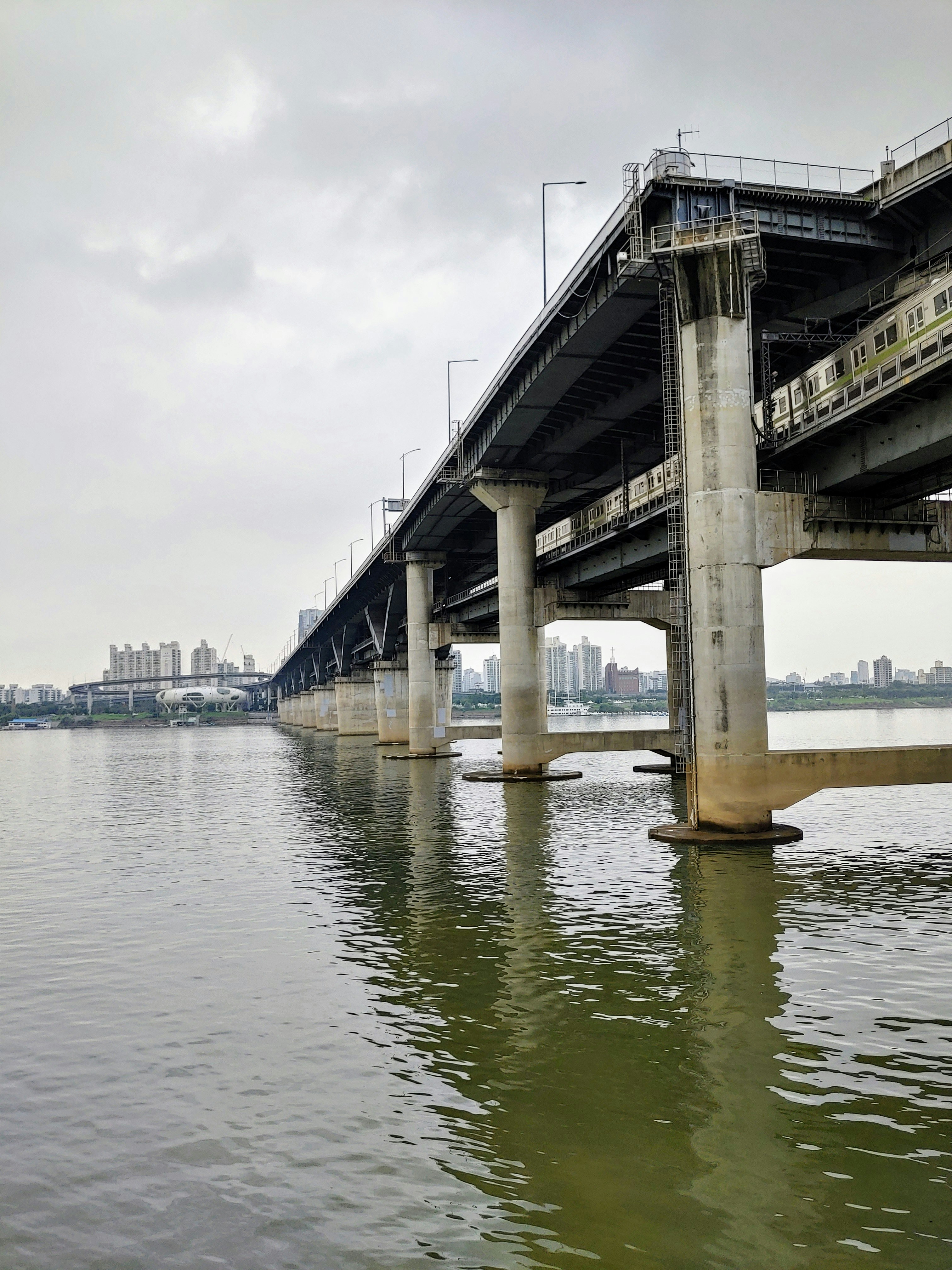 Gray concrete bridge over body of water during daytime photo – Free ...