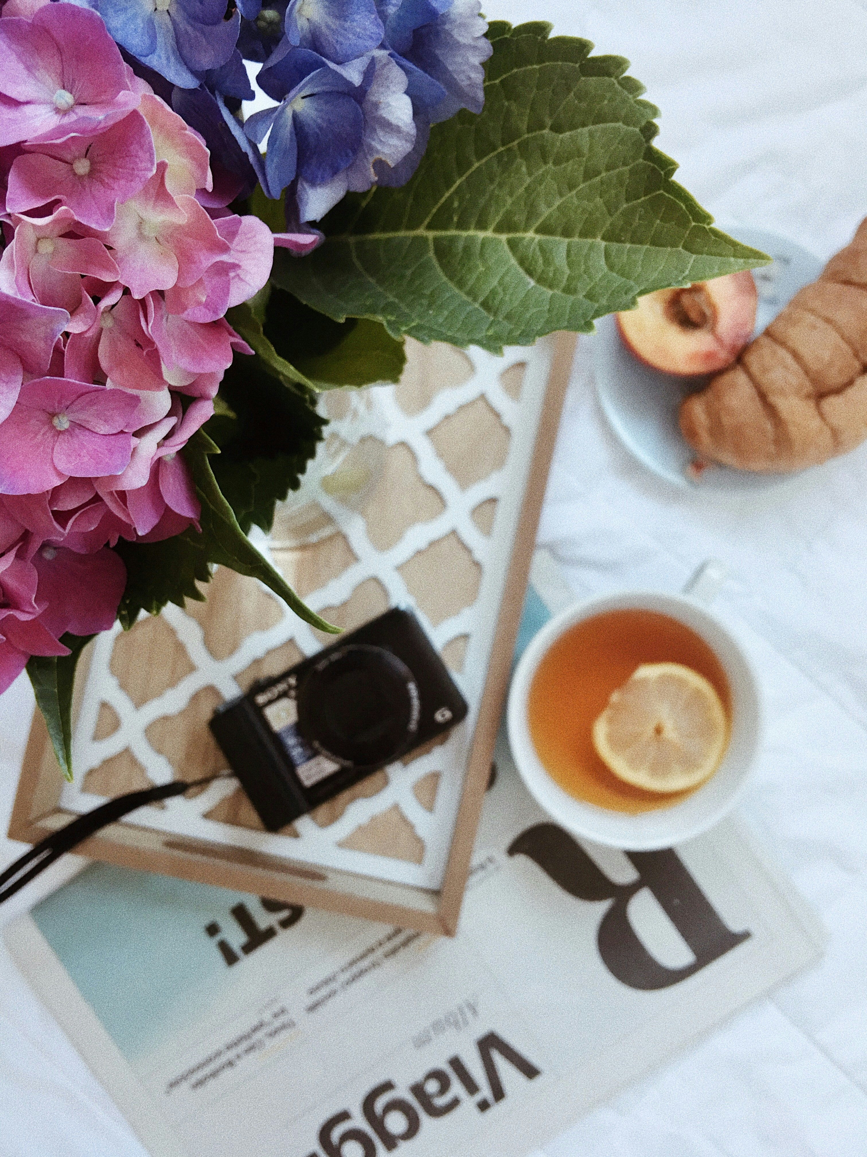 Pastel Hydrangeas, a Pocket Camera, and Citrus Tea on a Morning Flat-Lay