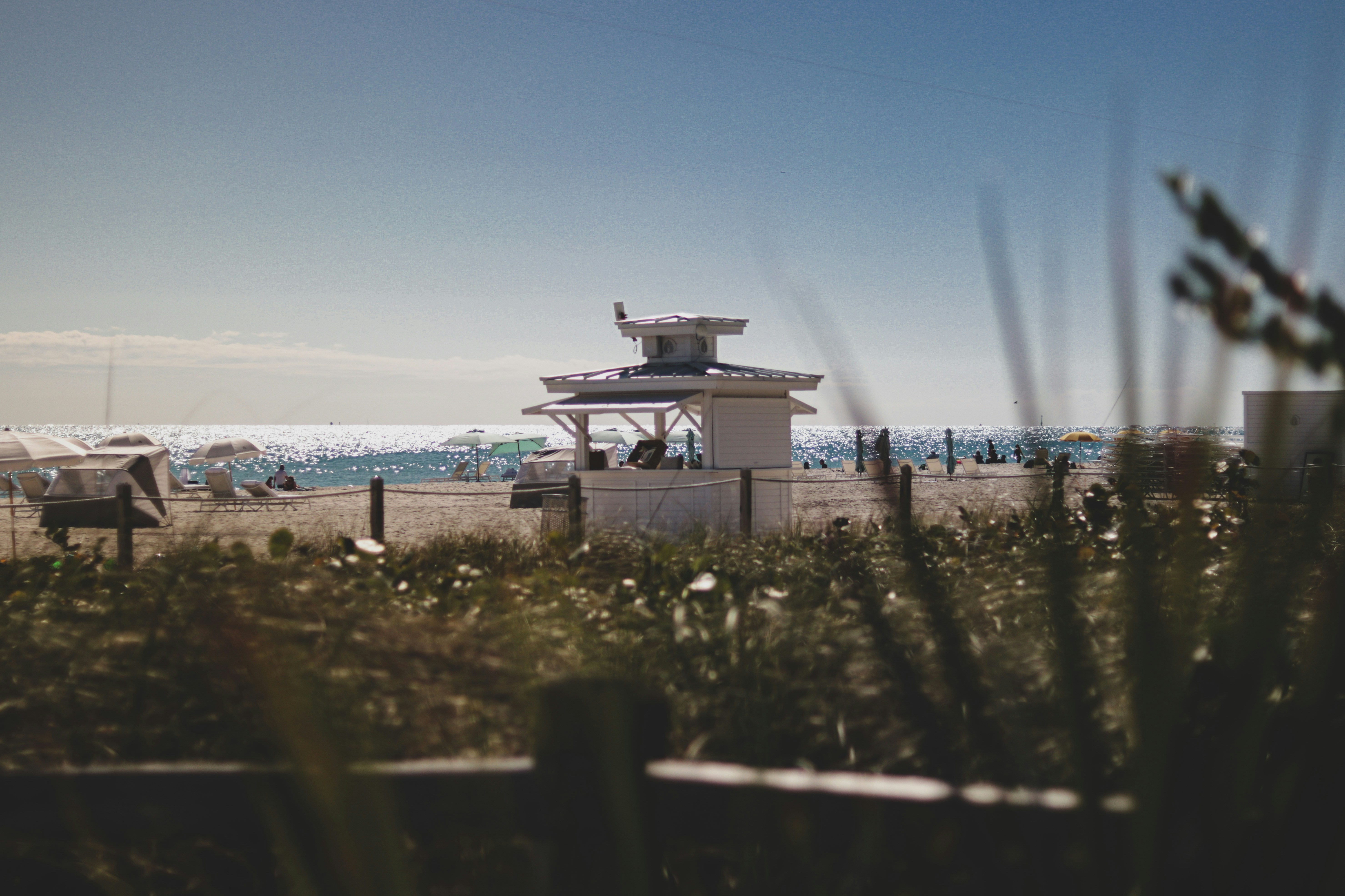 White wooden lifeguard house on seashore during daytime photo – Free ...