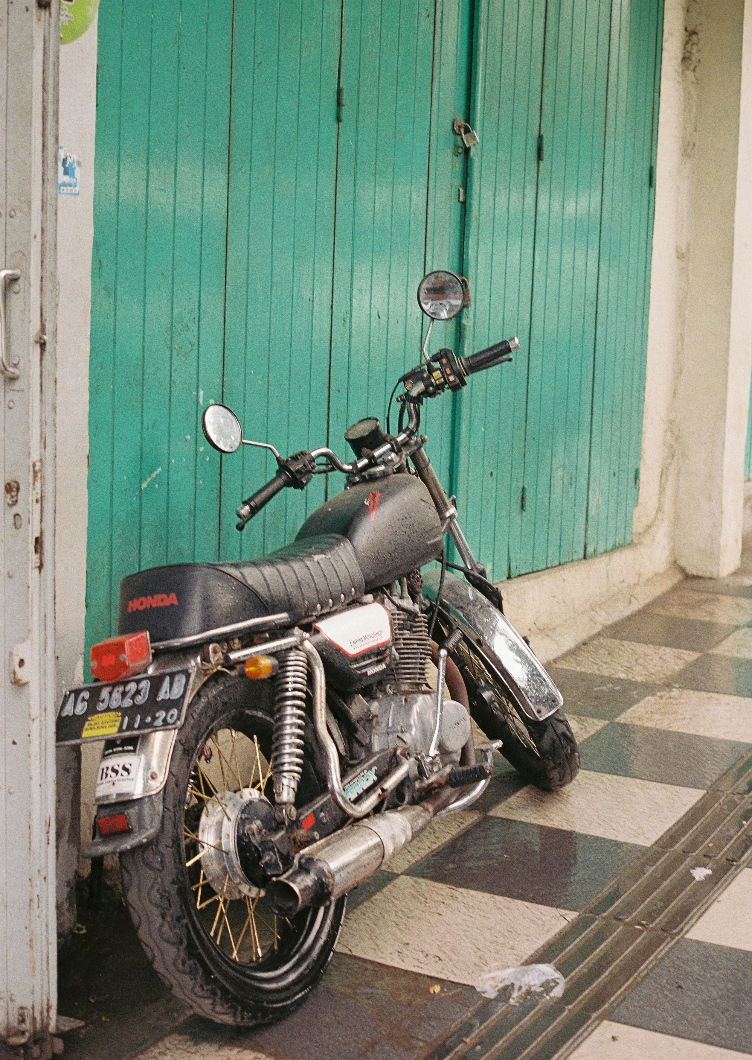 Honda at Rest by a Mint-Green Gateway: Chrome, Leather, and Quiet Street