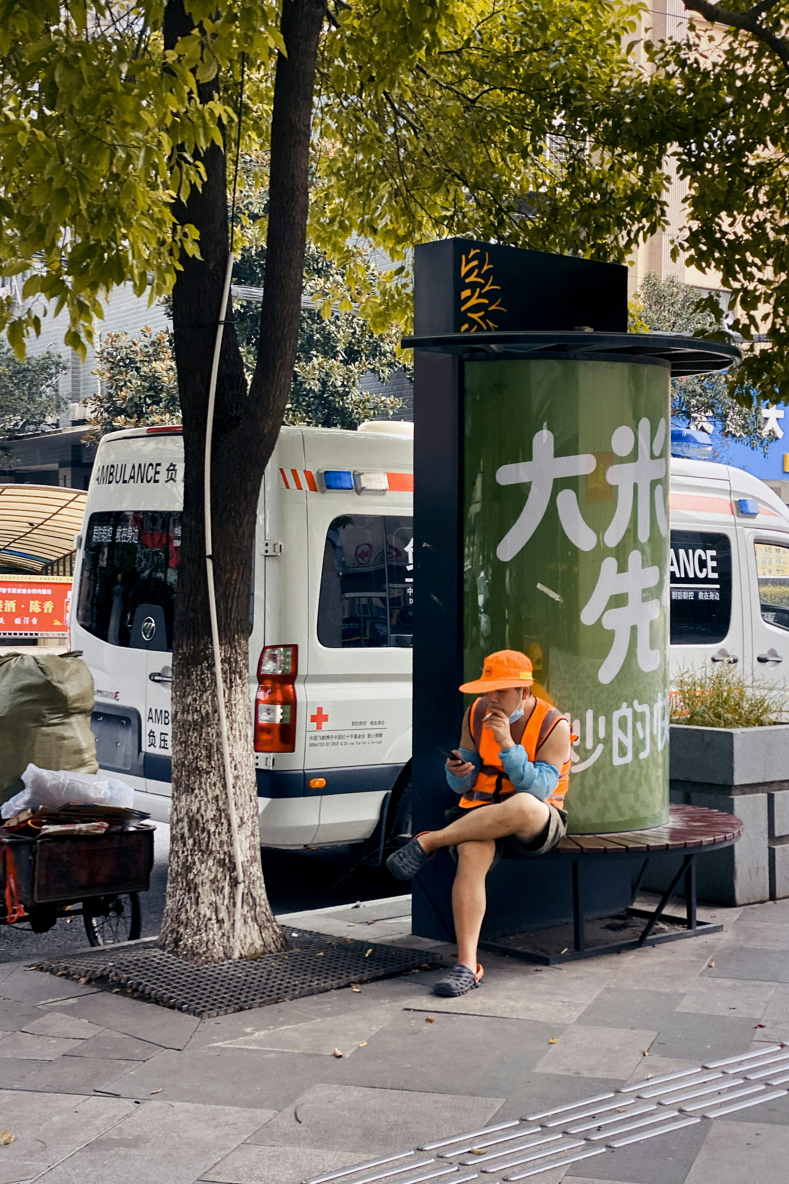 woman in blue denim shorts sitting on bench beside white van during daytime