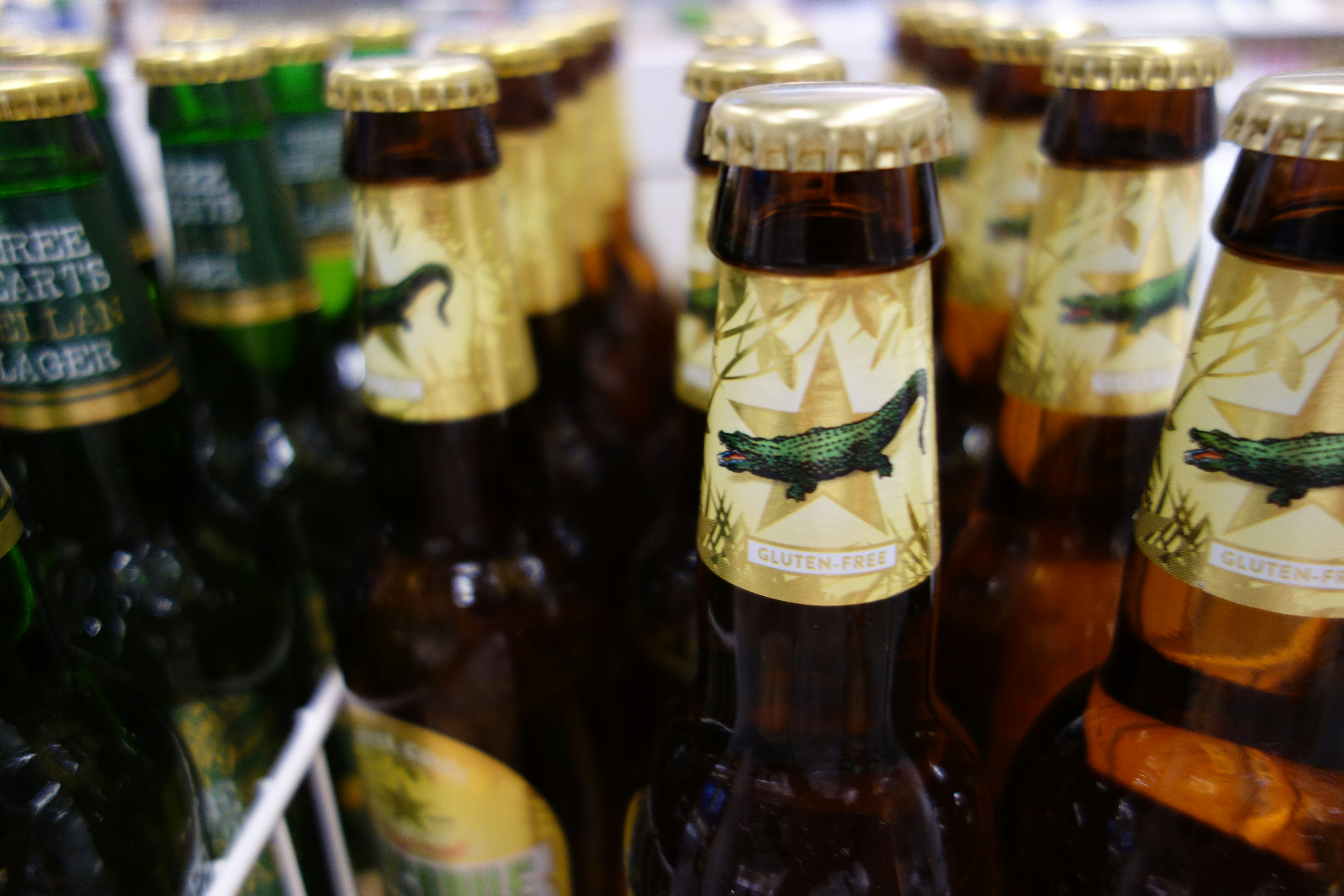 brown glass bottles on white steel rack