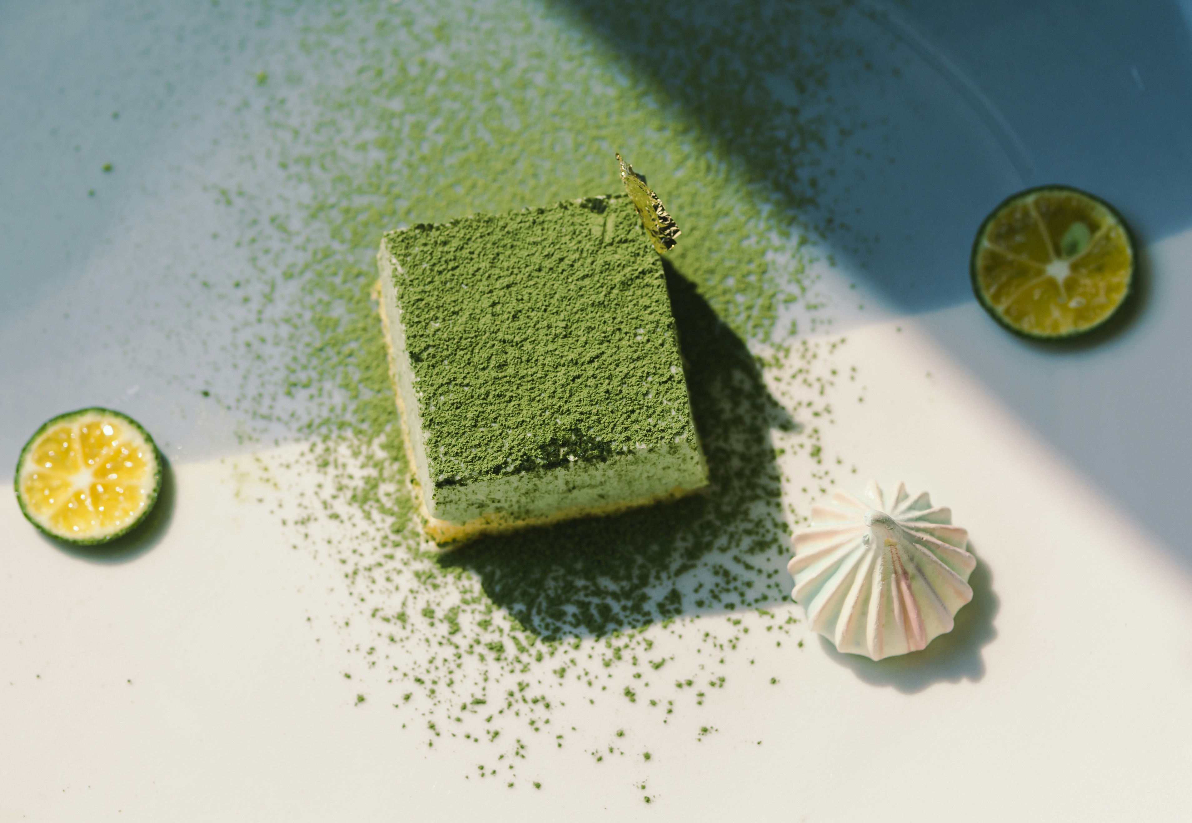 Matcha Cube Among Citrus Halves and a Petite Meringue
