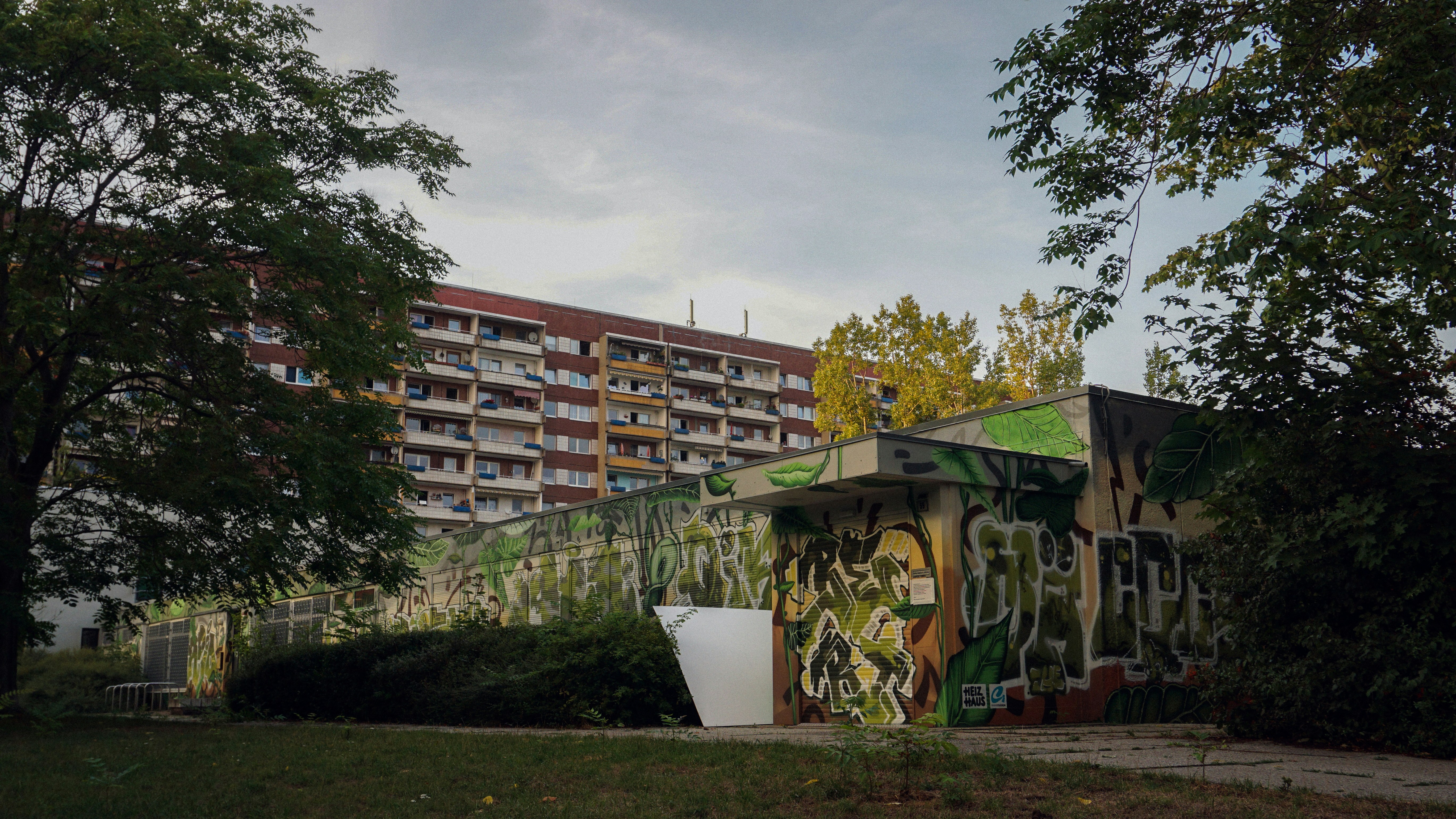 brown concrete building near green trees during daytime