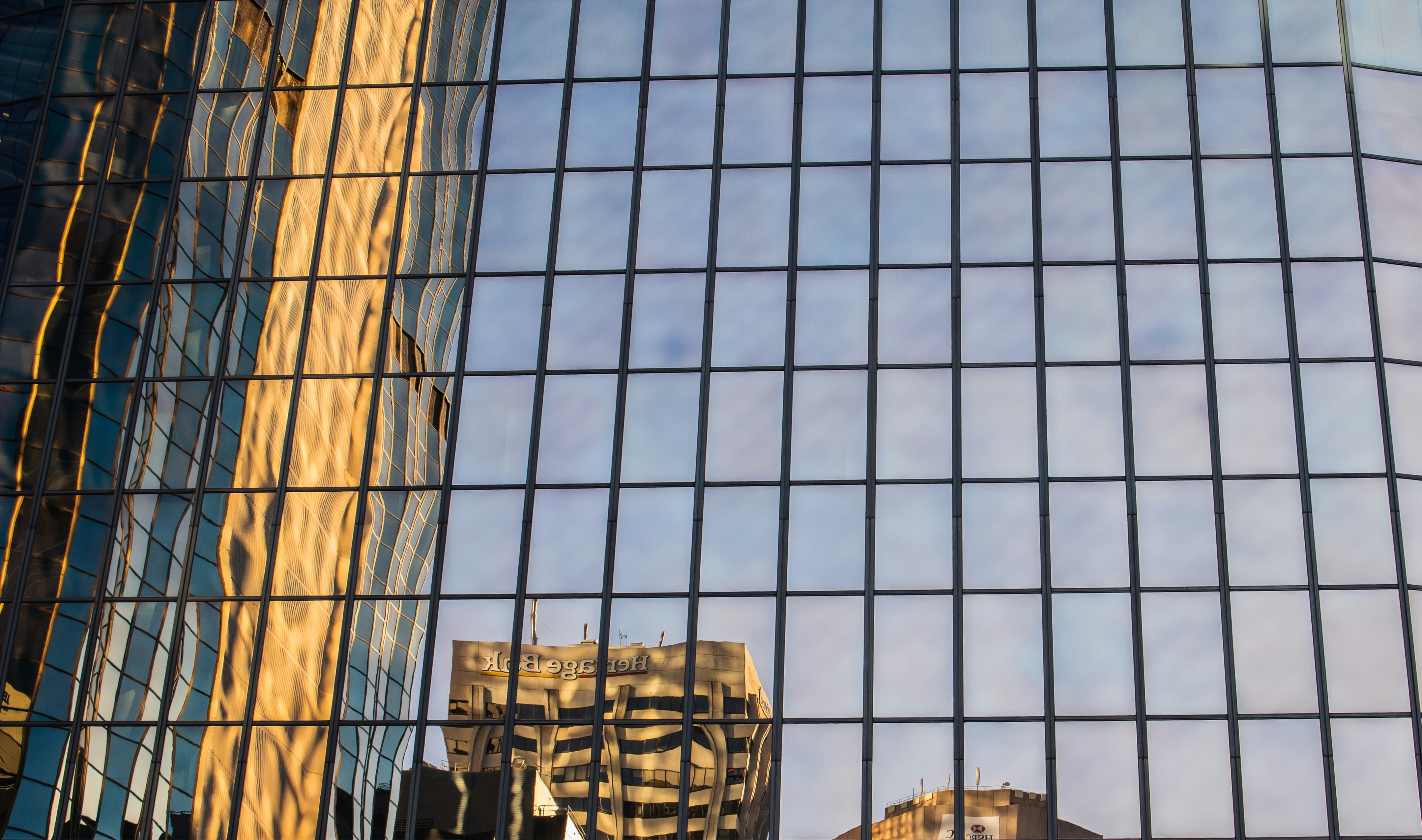 Grid Reflections: City Glass and Golden Facades