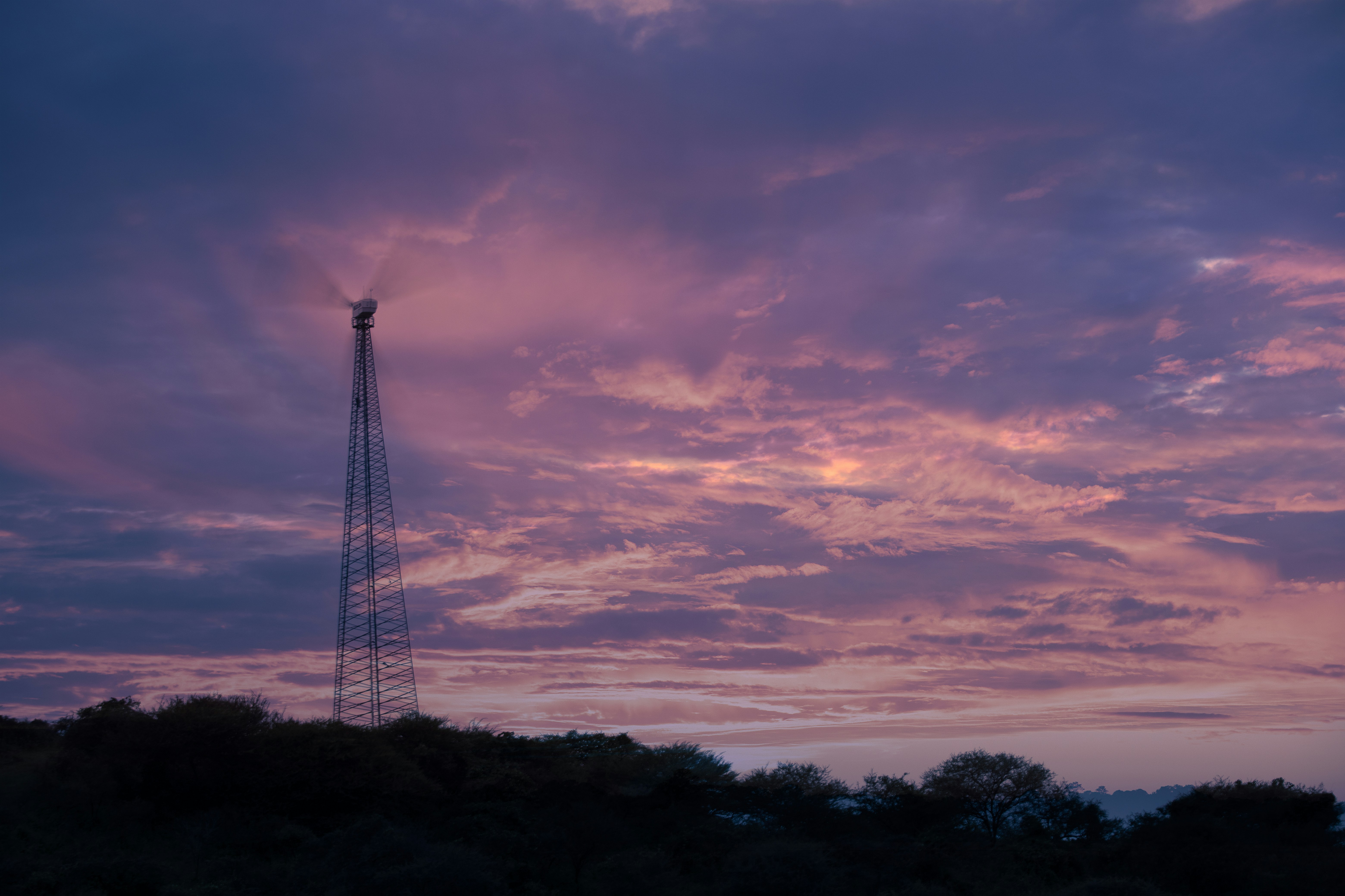Dusk Tower Under Violet Skies: a lone transmitter frames the horizon