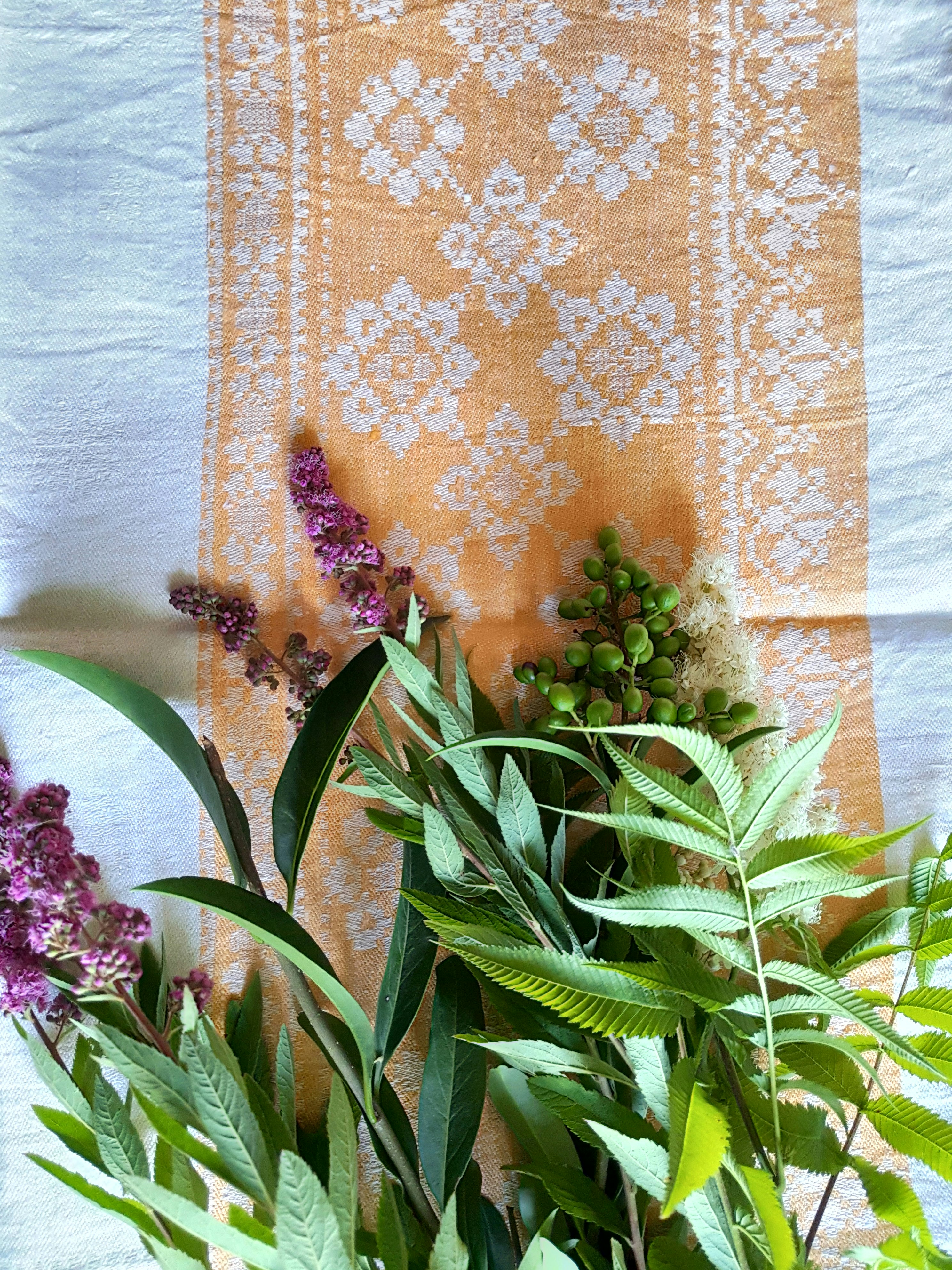 purple flowers on brown textile