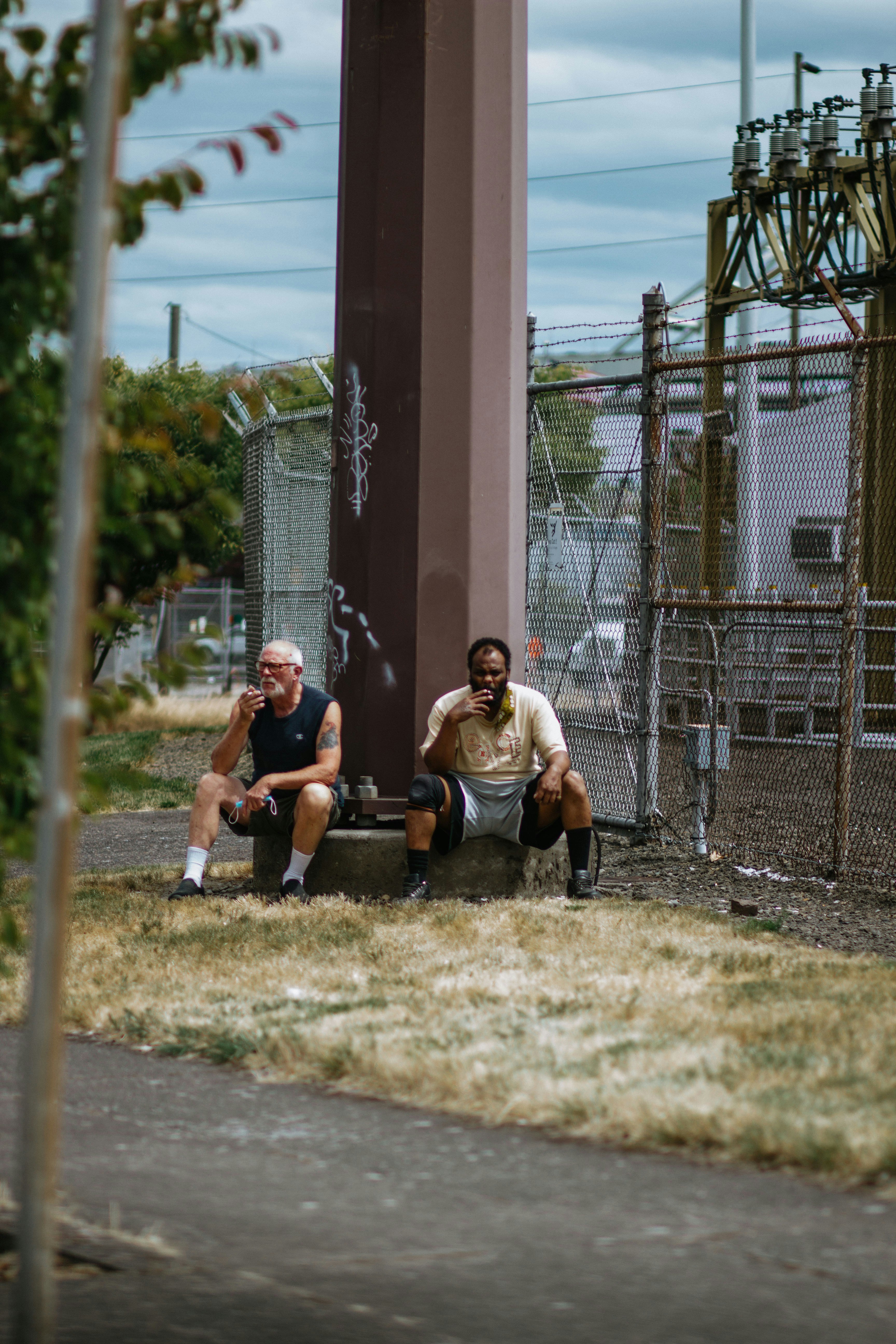Man in black tank top sitting on black and white basketball hoop photo ...