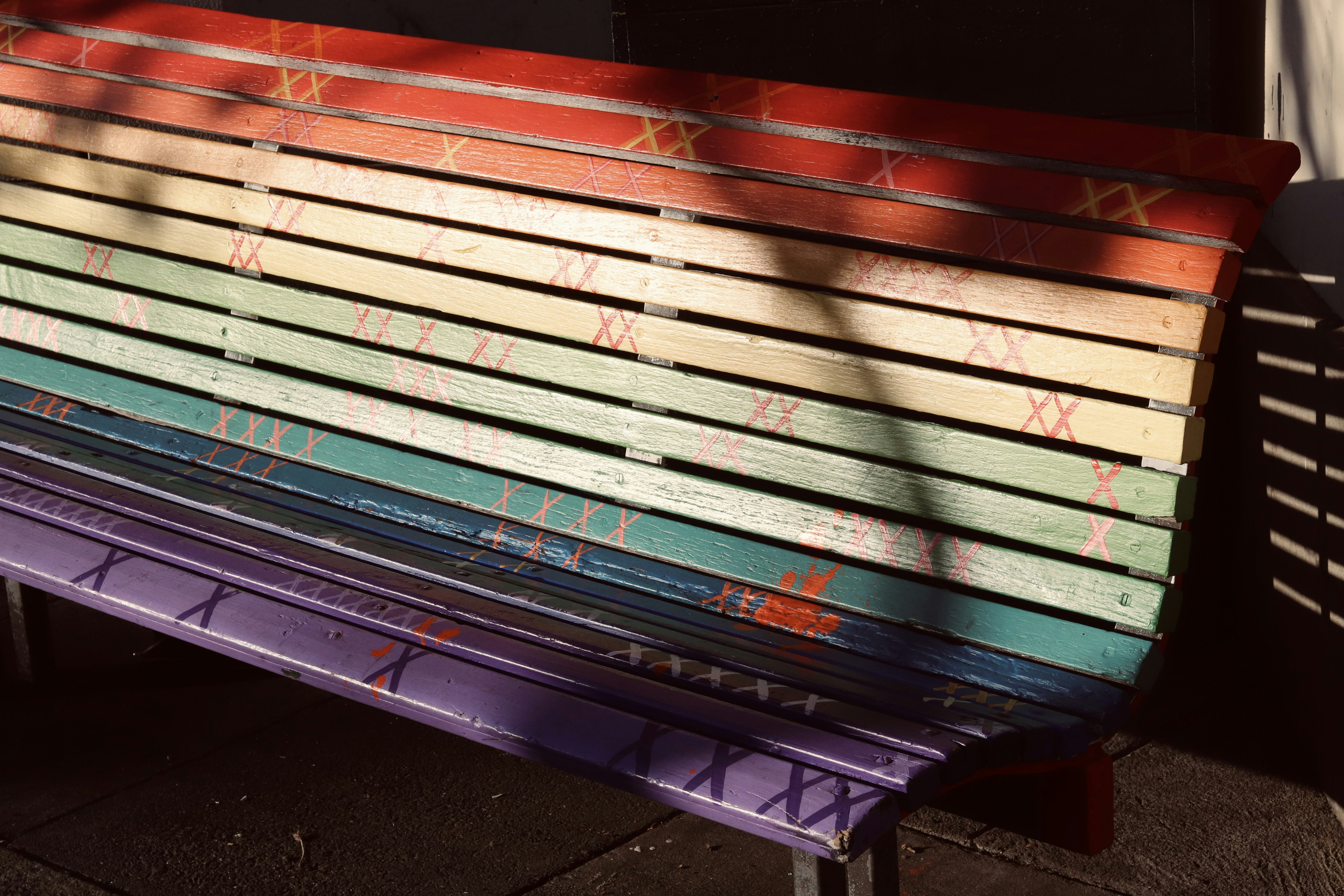 Sunlit Spectrum: Rainbow Bench Under Lattice Shadows