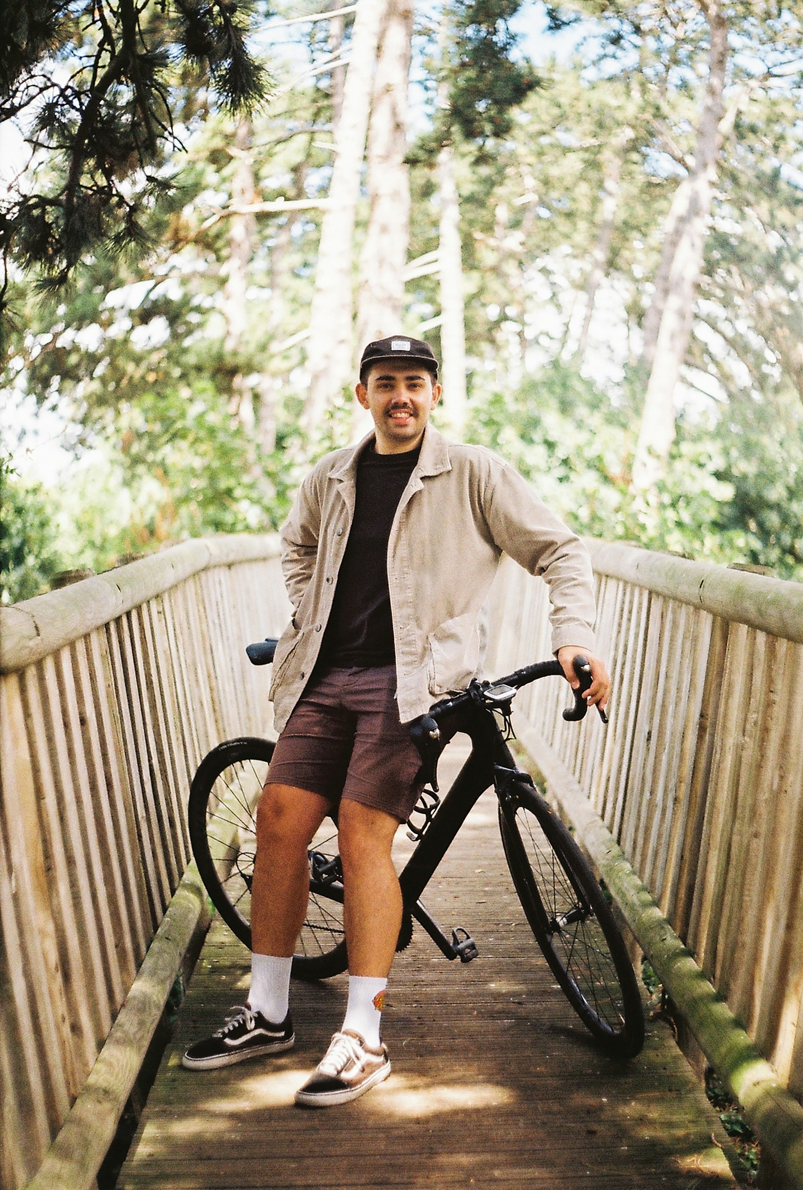 Casual Cyclist on Forest Bridge
