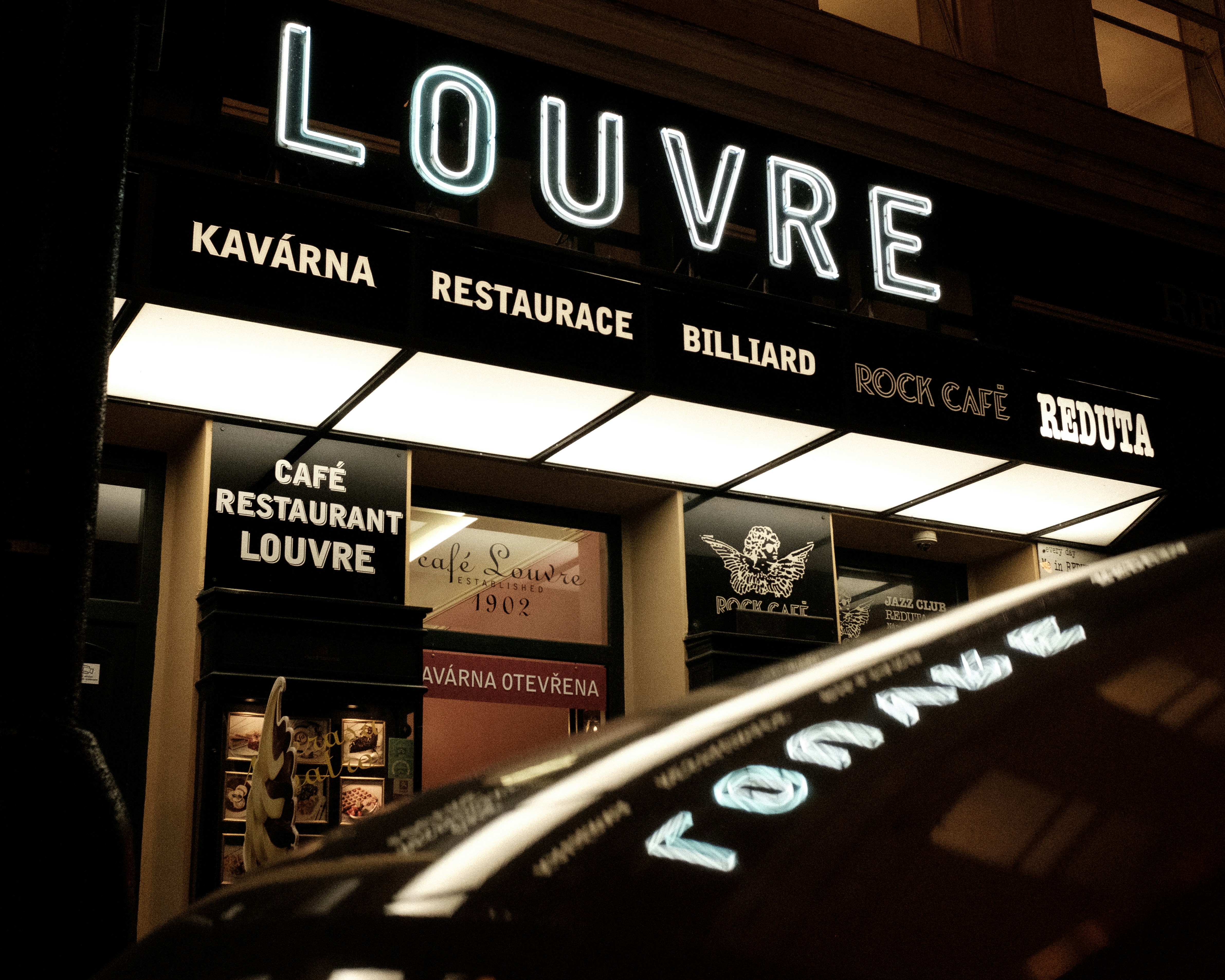 A restaurant called louvre lit up at night photo – Free Prague Image on ...