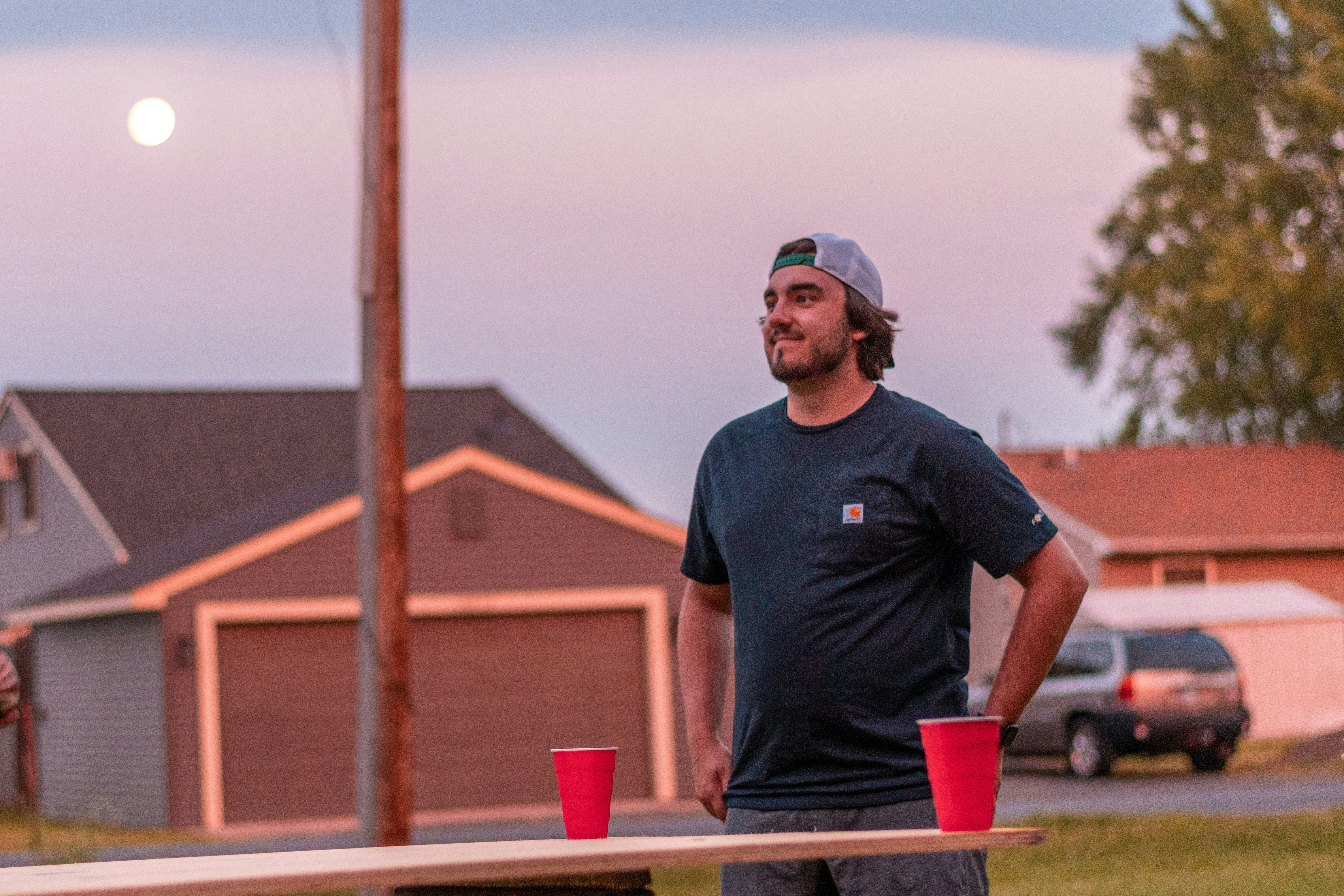 Twilight Table Games: A Suburban Moment Under a Rising Moon
