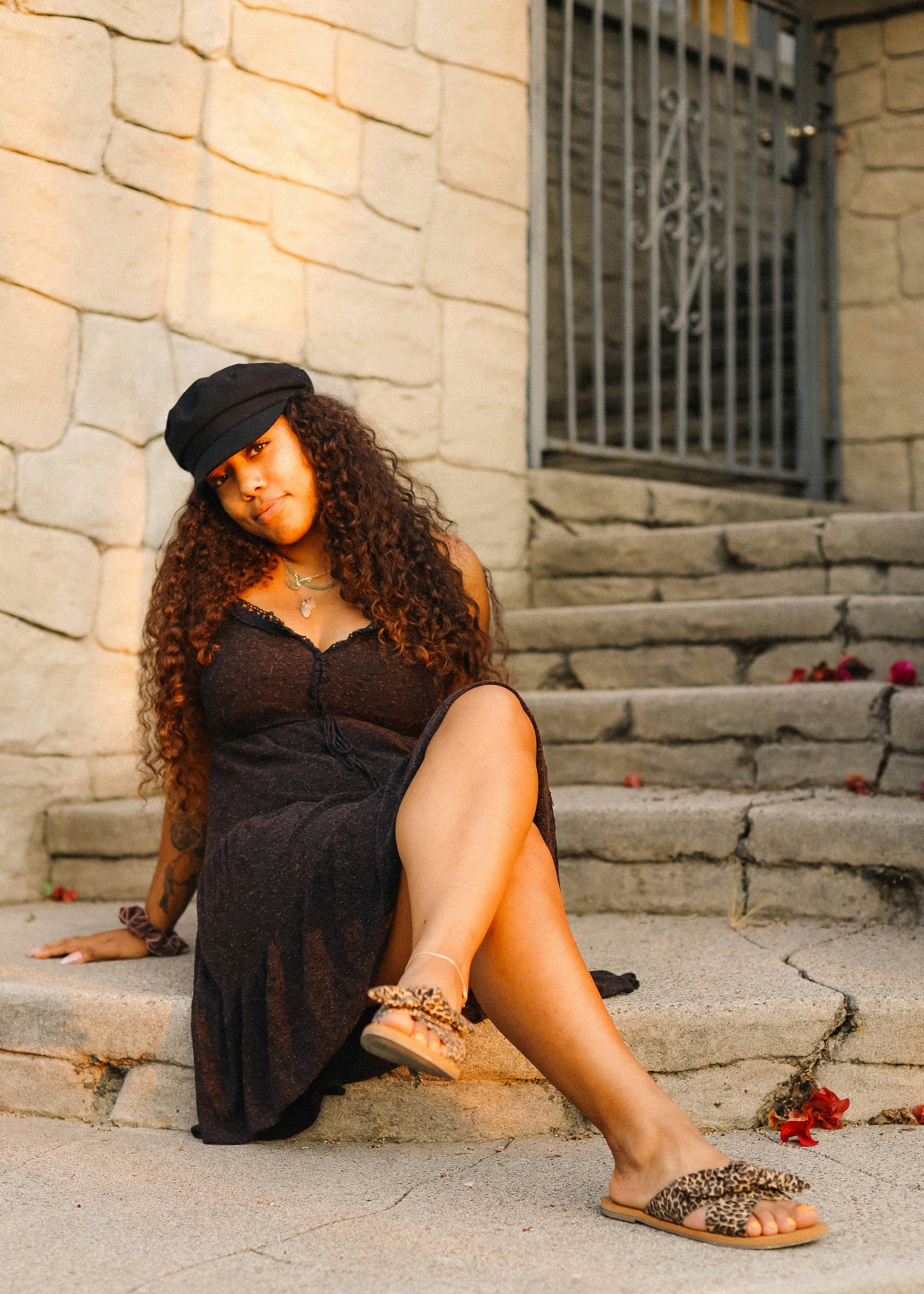 Sitting on Stone Steps: A Quiet Poise in a Dark Dress
