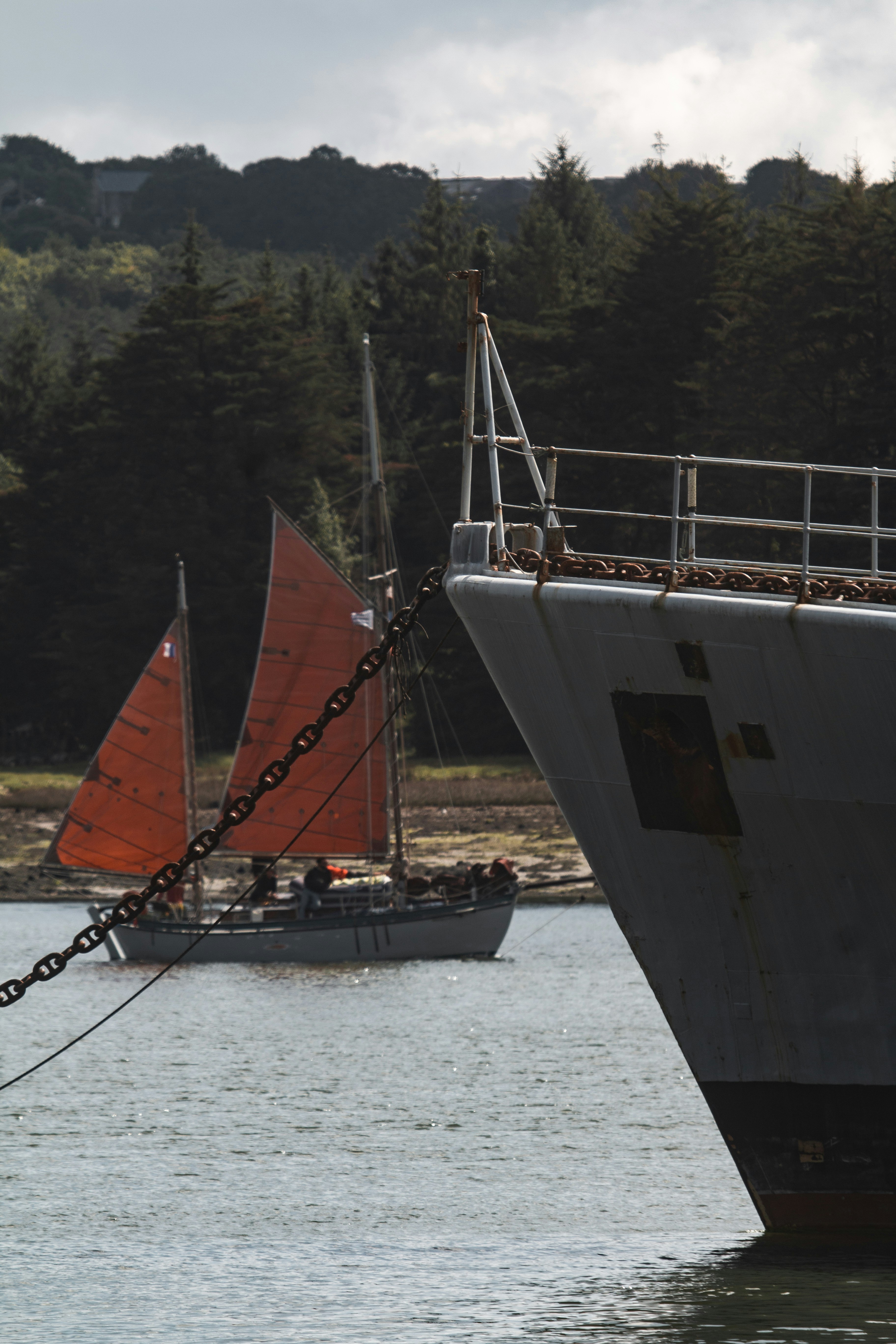 Iron Bow, Orange Sails: A Harbor Portrait