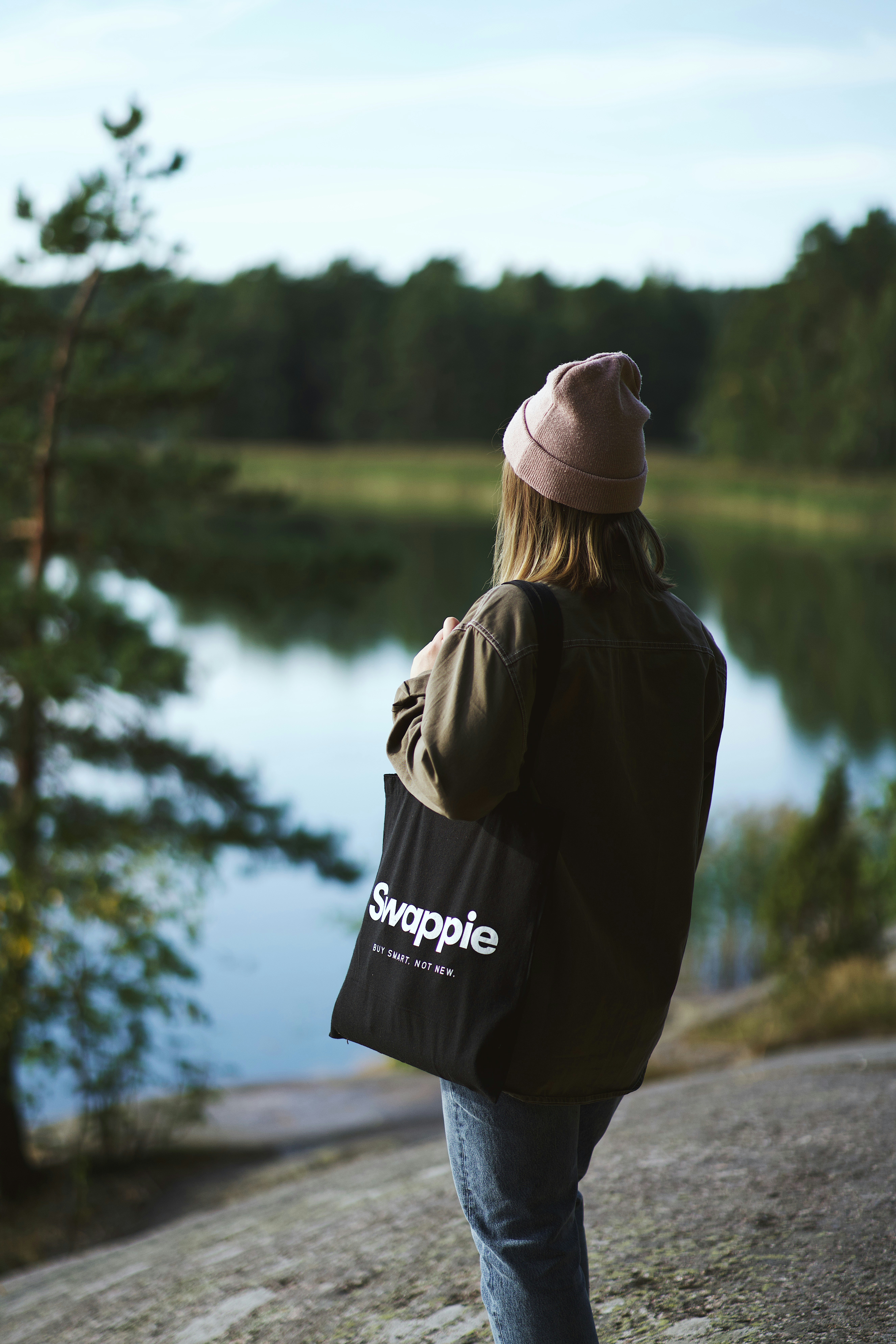 Quiet Horizon: A Woman with a Swappie Tote by the Lake