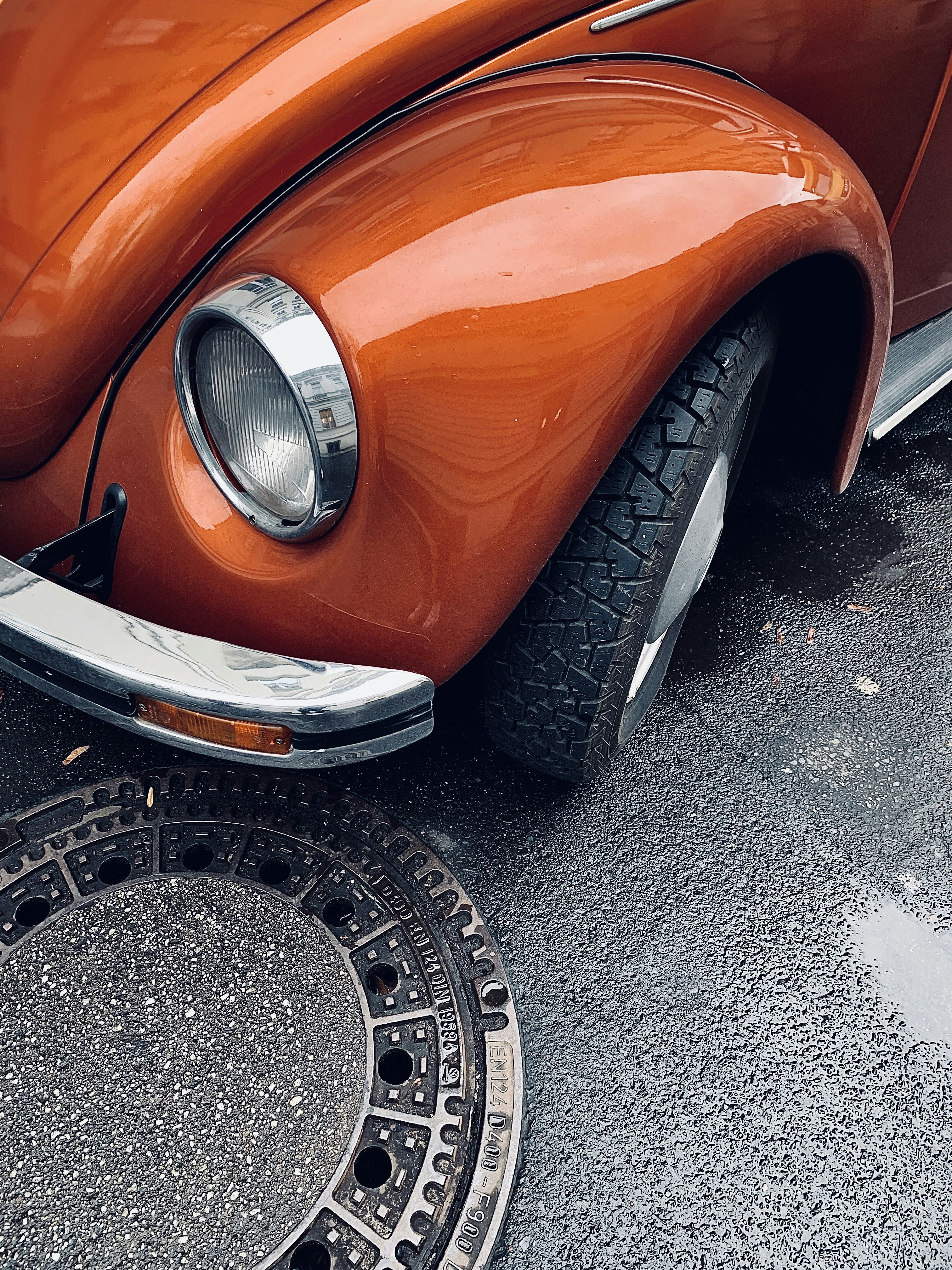 Orange Vintage Car Hood and Wheel Peek