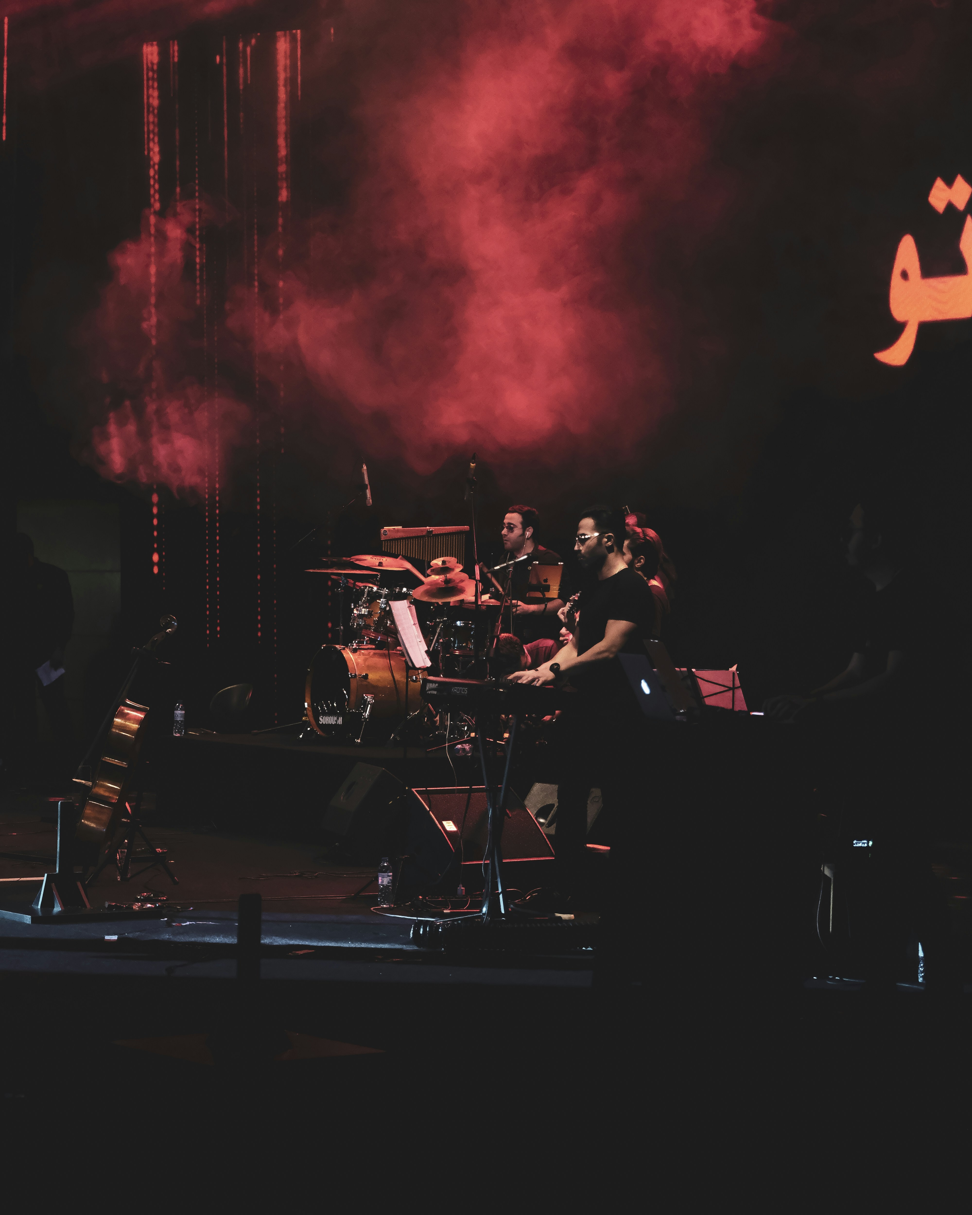Band performing on stage with red lights photo – Free Brown Image on ...