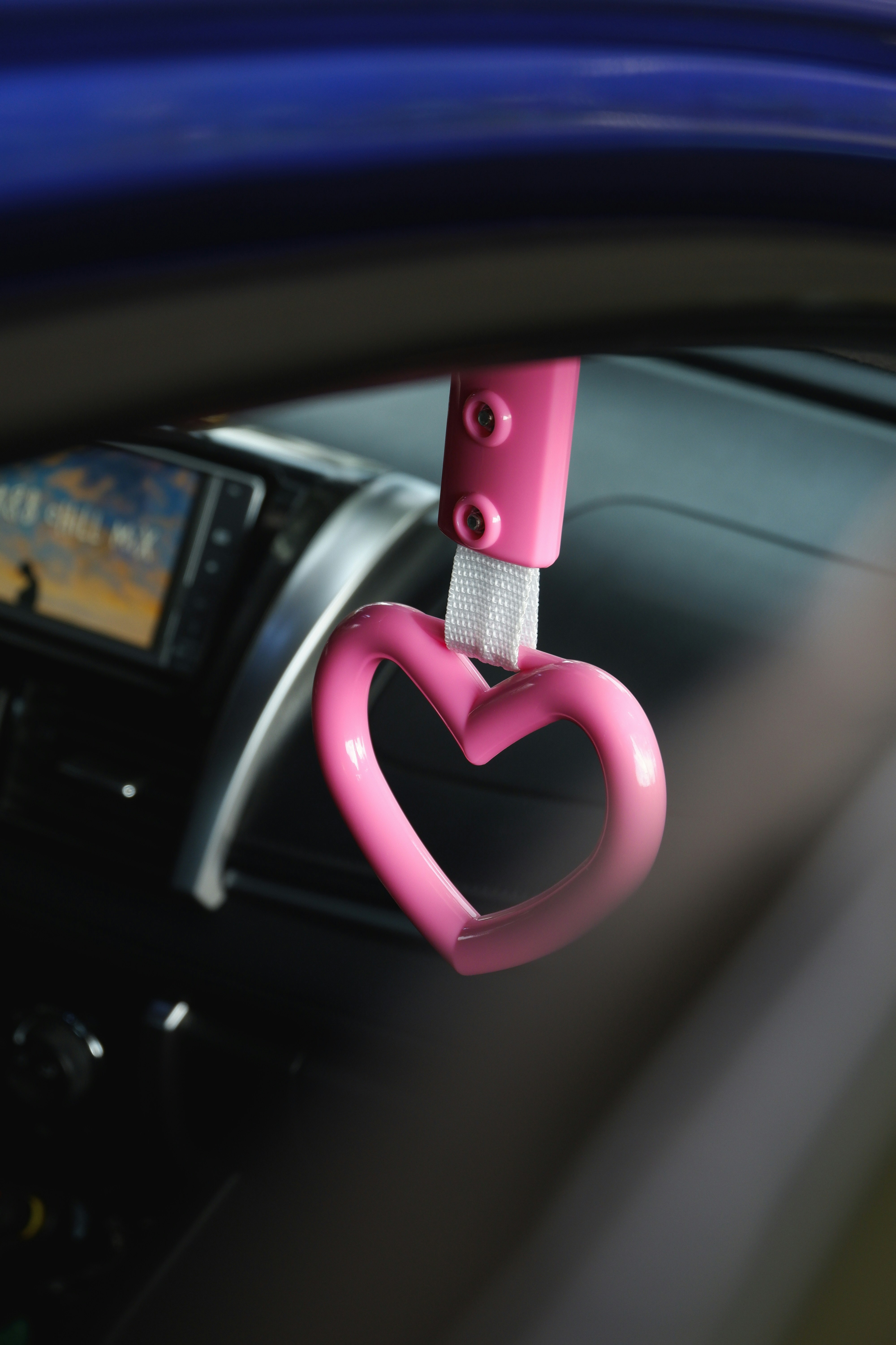 Pink Heart Pendant Framing a Quiet Car Moment