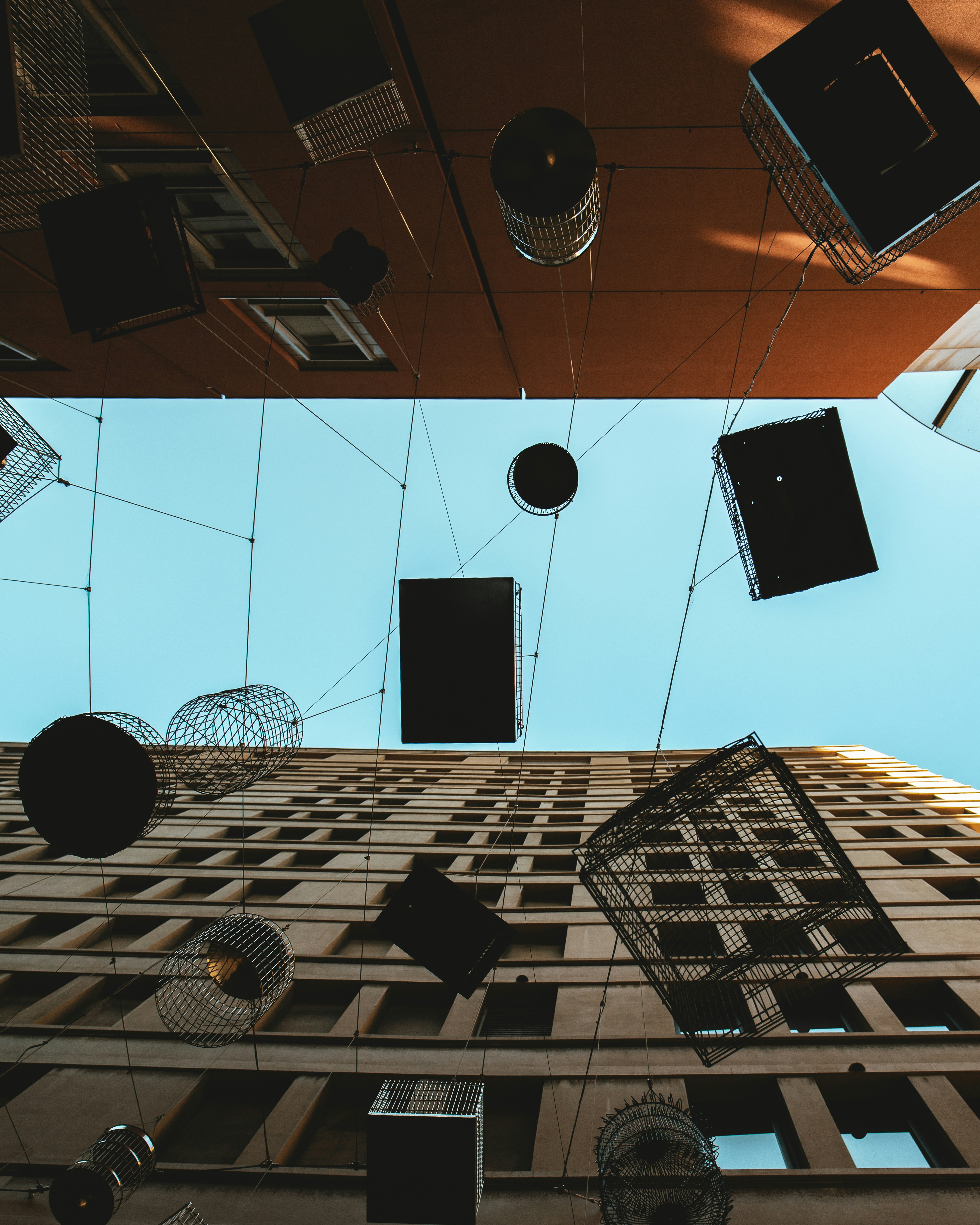 A group of square objects hanging from the ceiling photo – Free ...