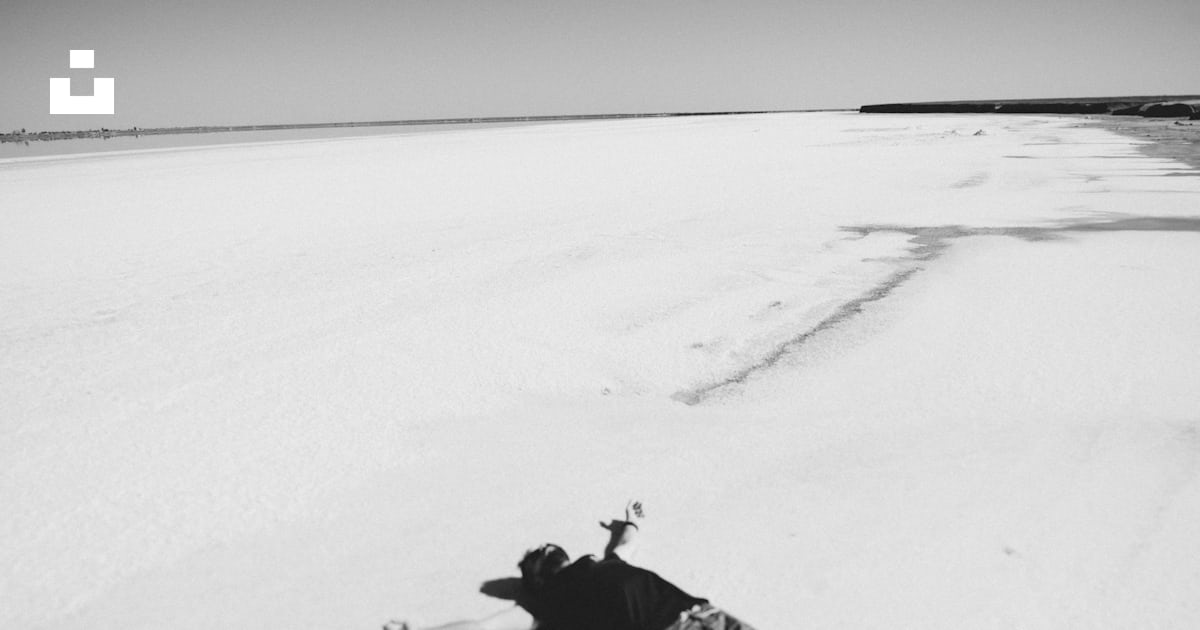 Grayscale Photo Of Woman In Bikini Lying On Beach Photo Free Blue Image On Unsplash
