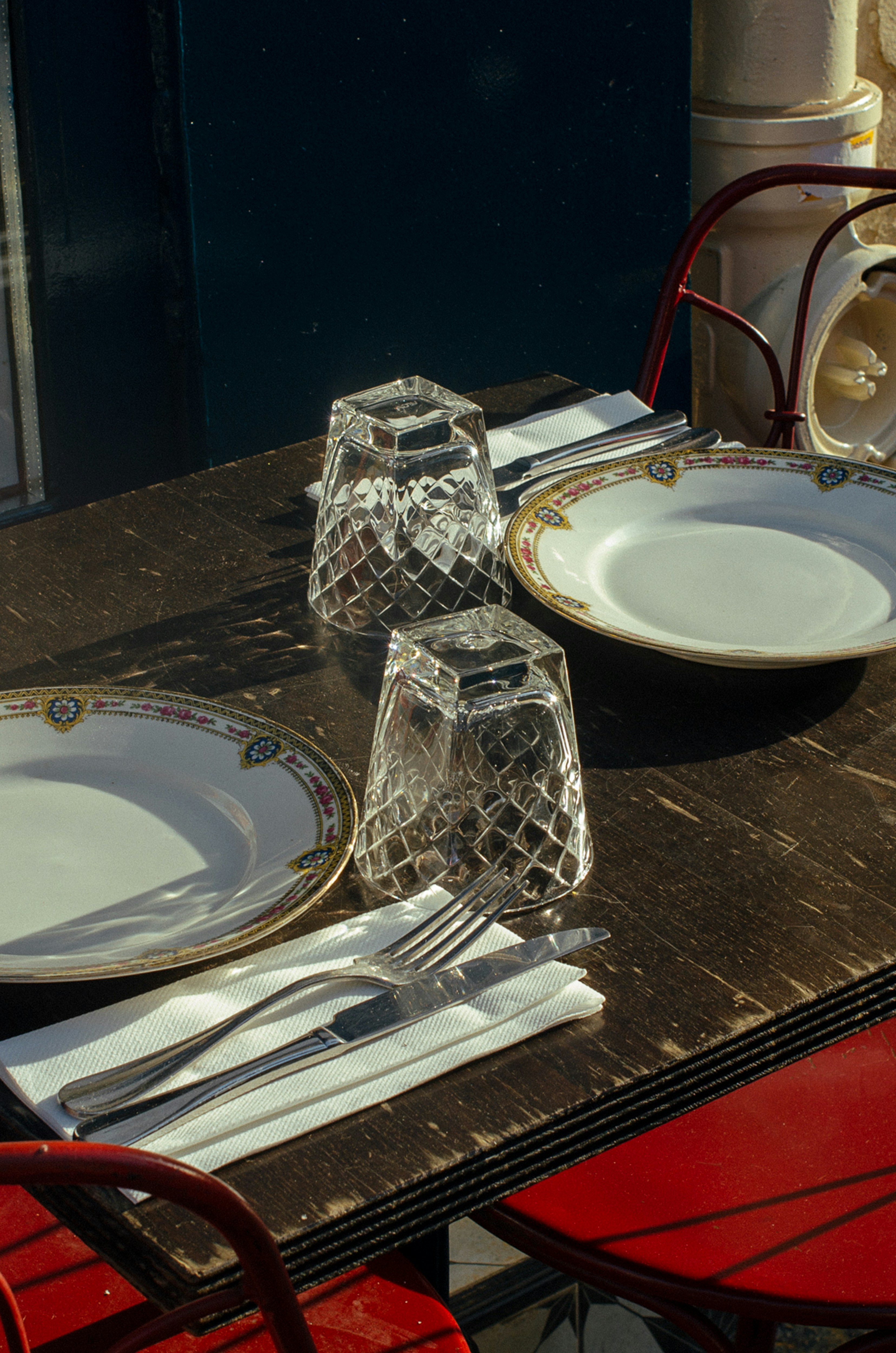 Tabletop Geometry: Crystal Glasses and Fine Dishware on a Rustic Wood Table