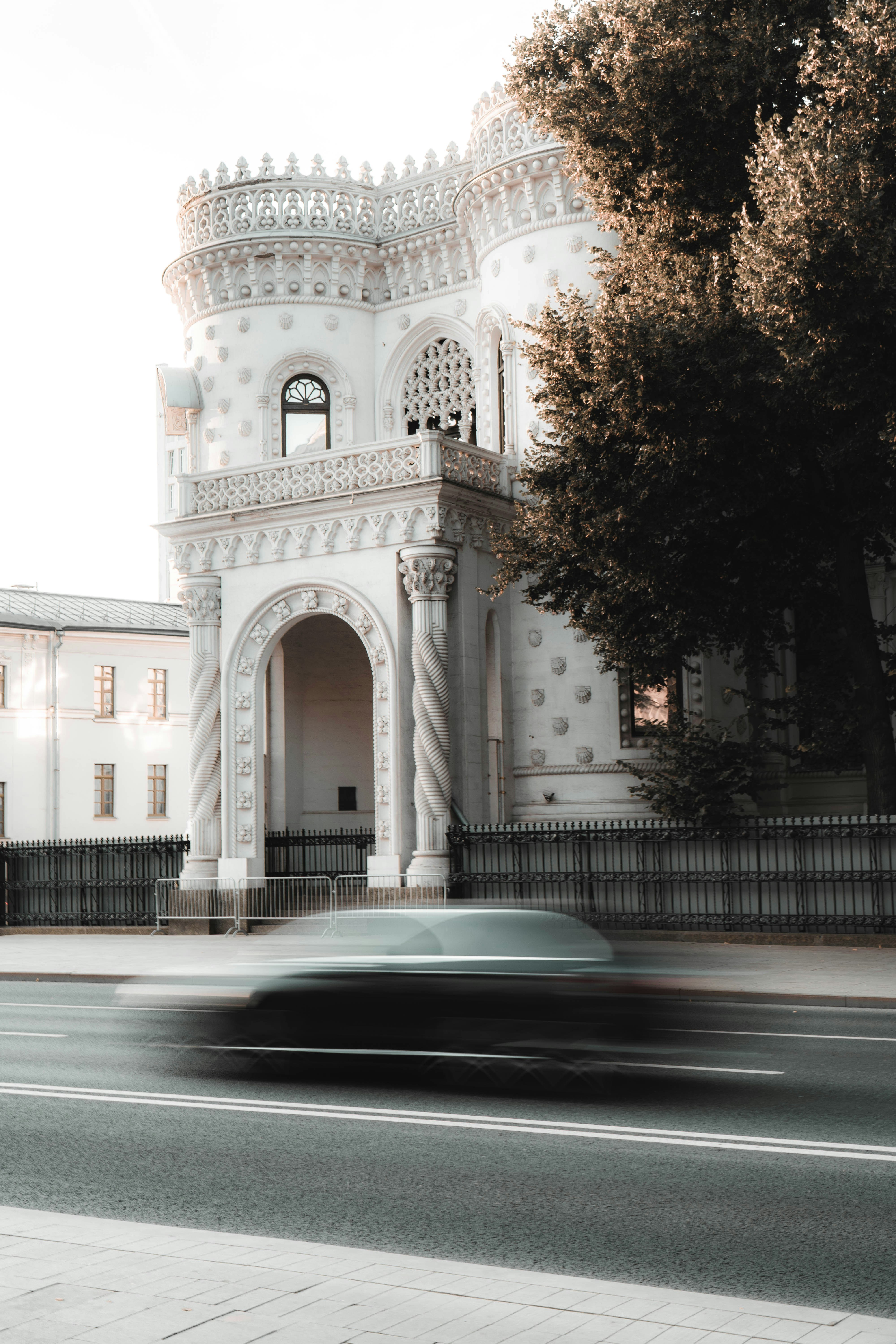 Ornate Gatehouse Halved by Night Traffic