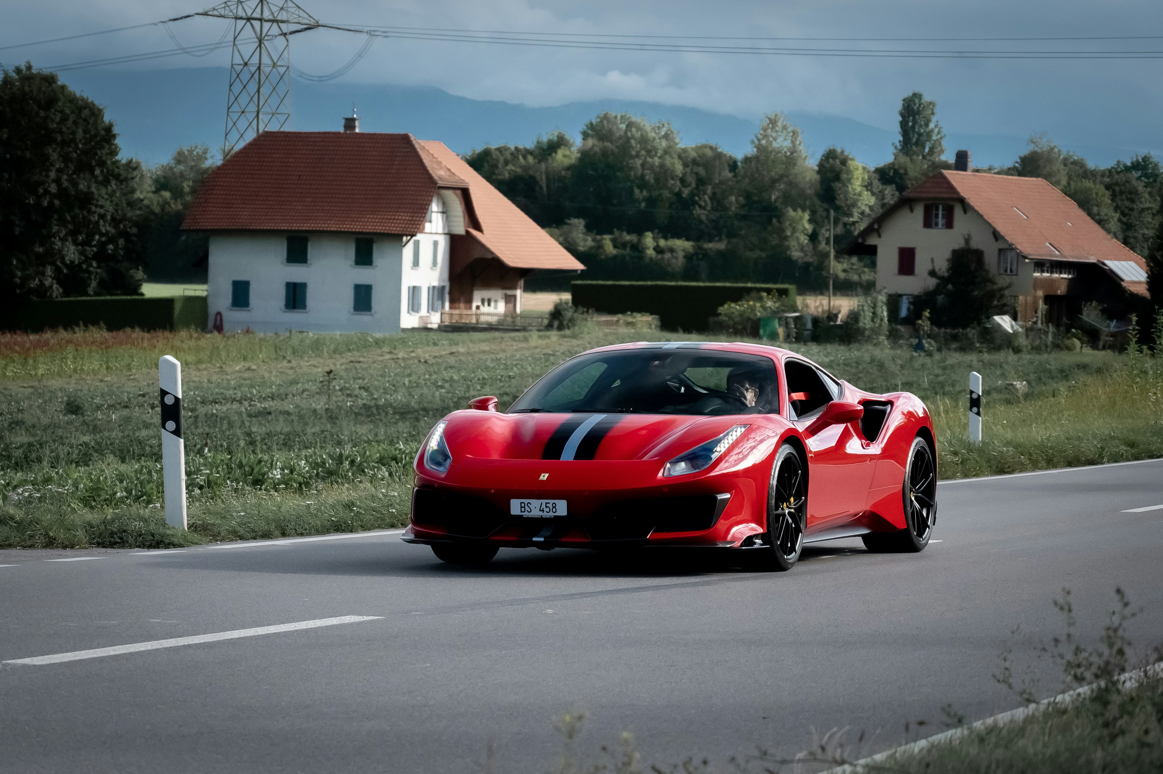 Crimson Ferrari Surging Along a Quiet Rural Road