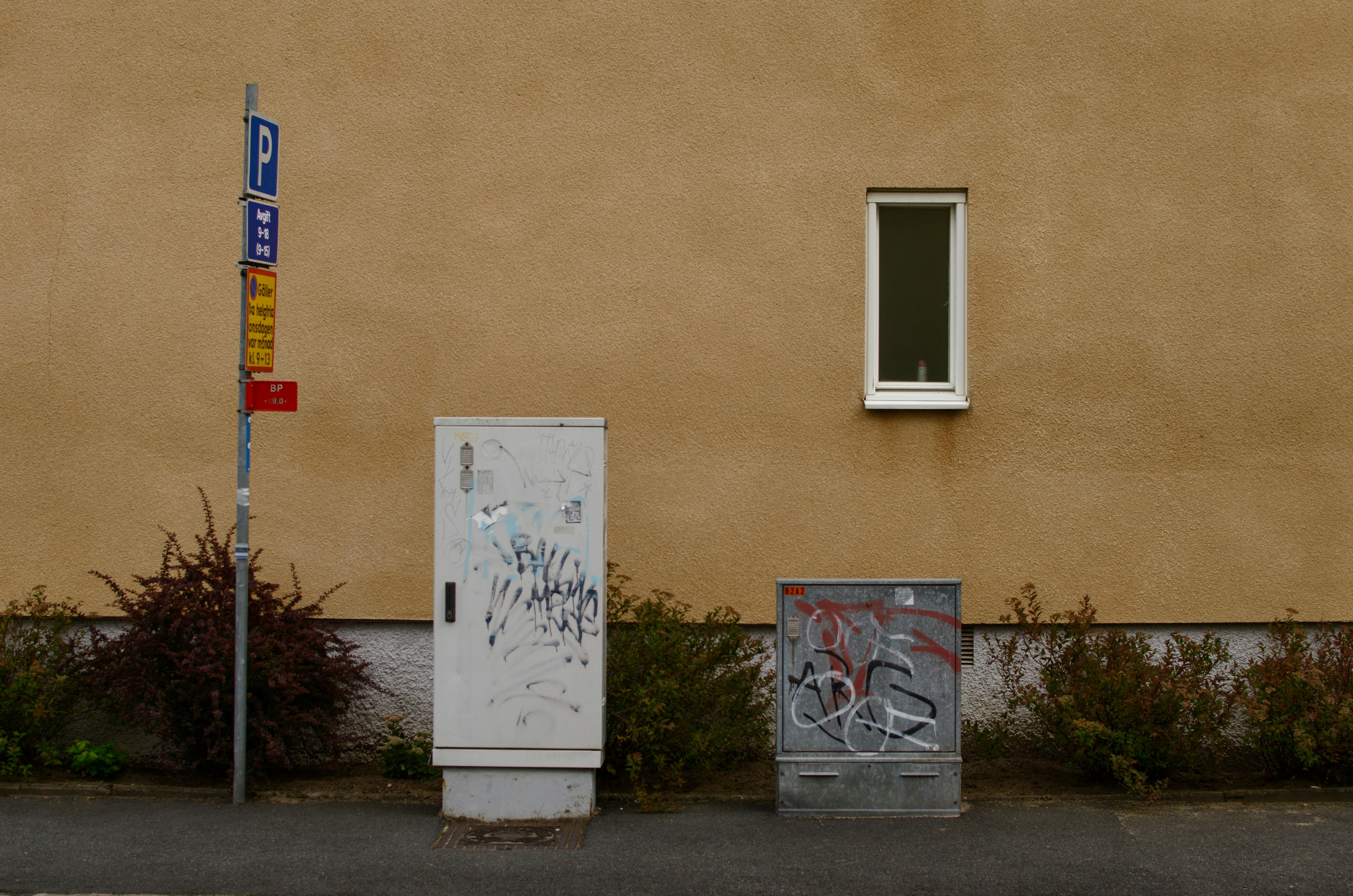 Urban Nerve Center: White Utility Box Framed by a Quiet Beige Wall