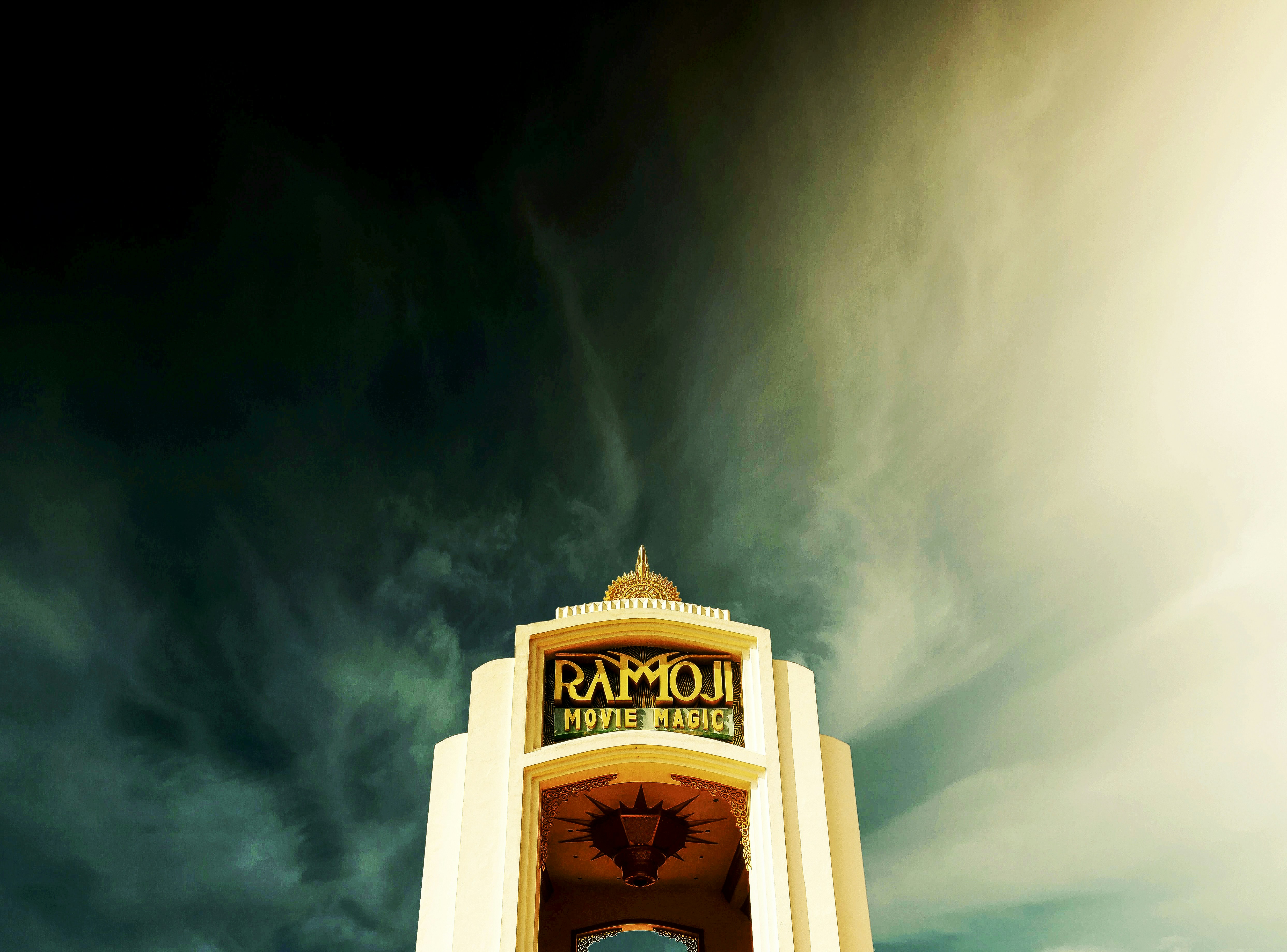 A very tall white building with a clock on it's side photo – Free ...