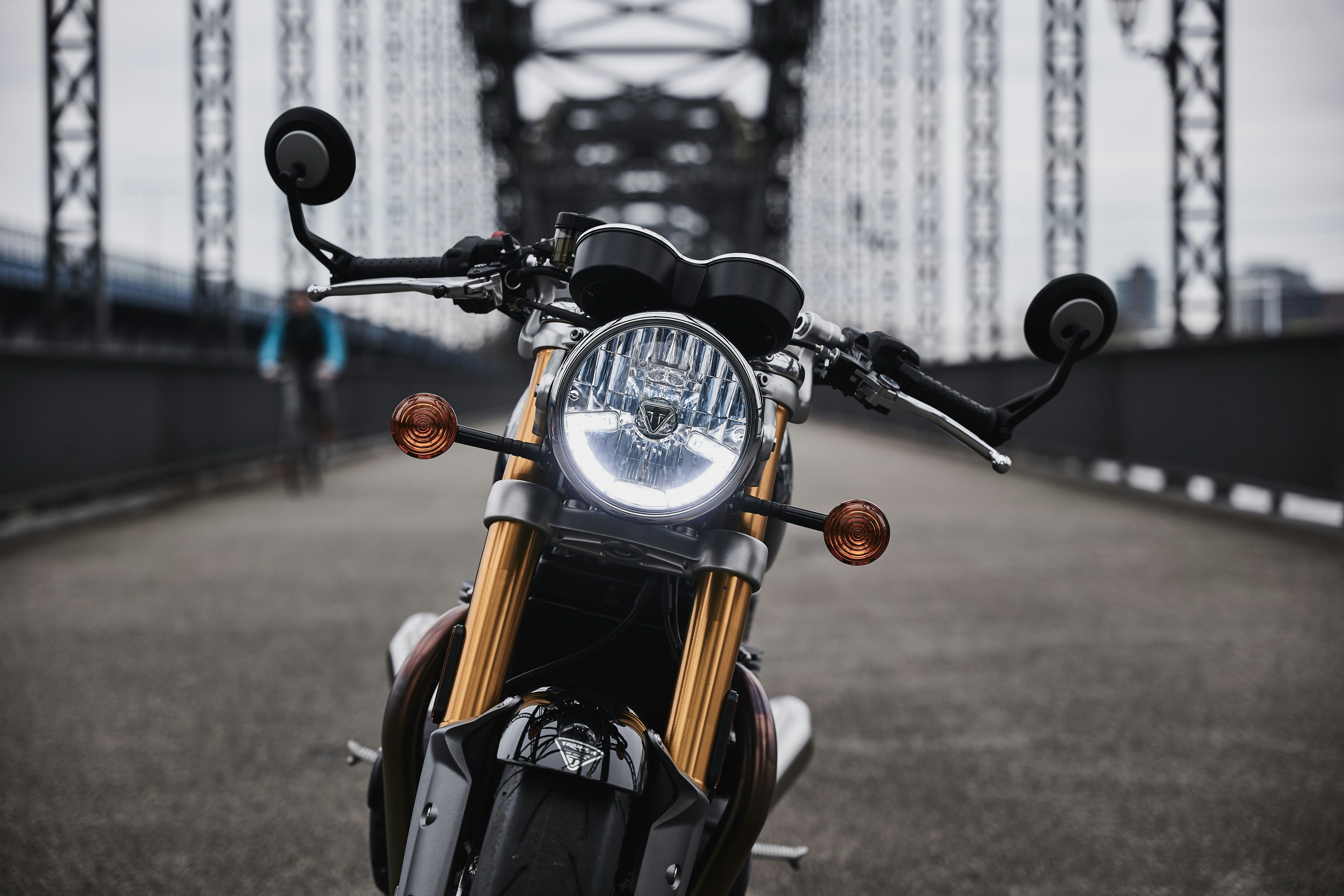 Black and brown motorcycle parked on gray concrete road during daytime ...