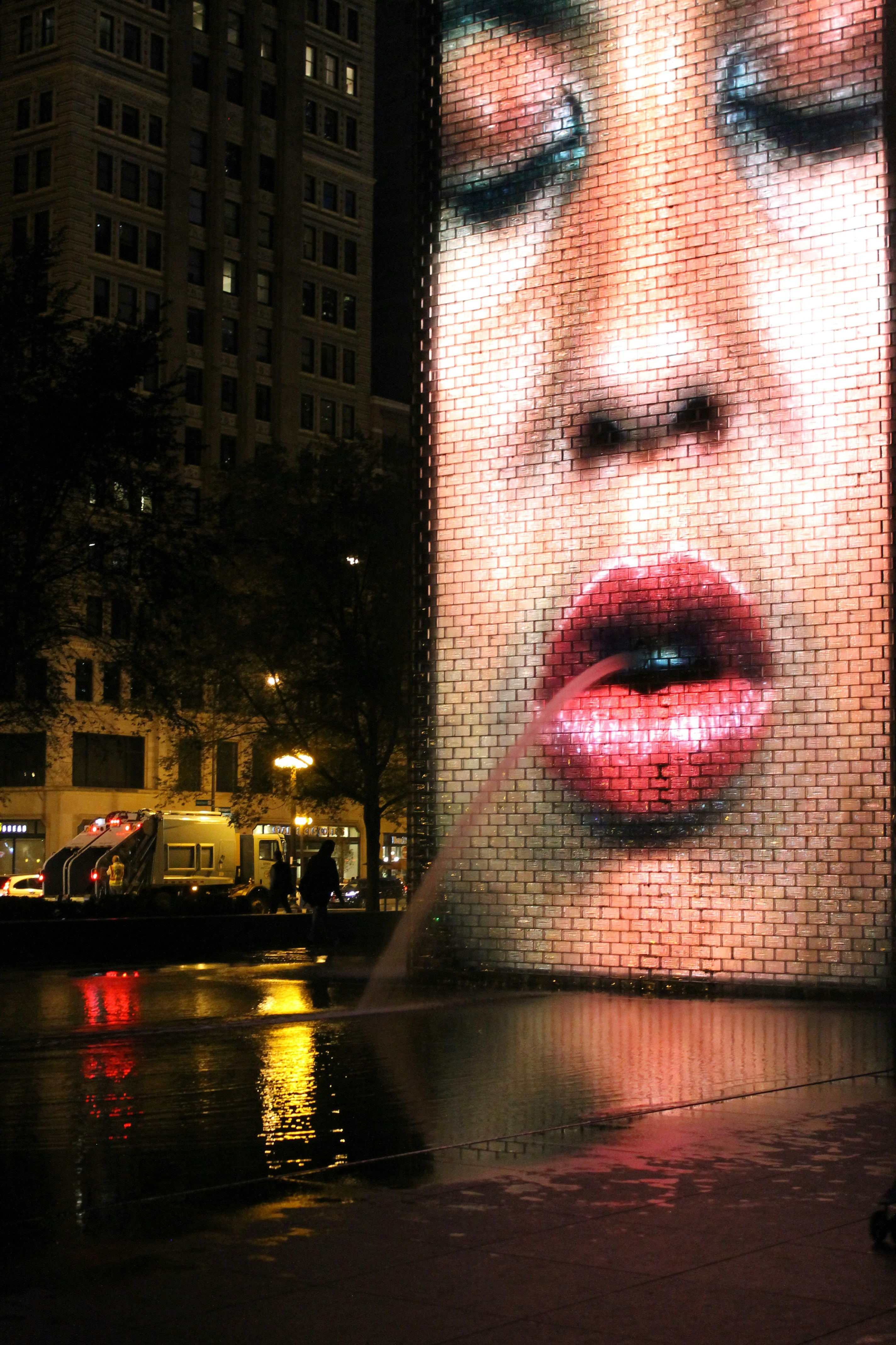 Giant Lip Portrait Illuminated by Night City